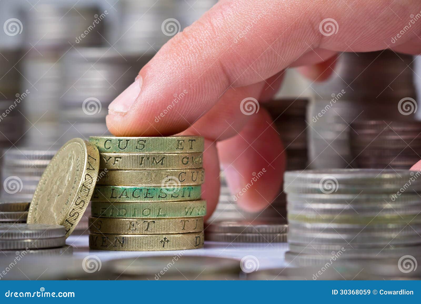 Closeup of an Index Finger Taps on a Stack of British Pound Coin Stock ...