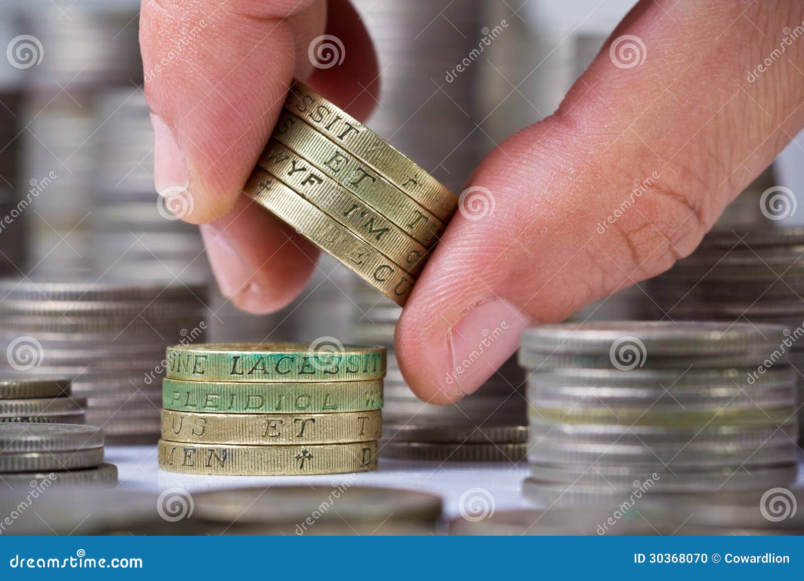 Closeup of an Index Finger Taps on a Stack of British Pound Coin Stock ...