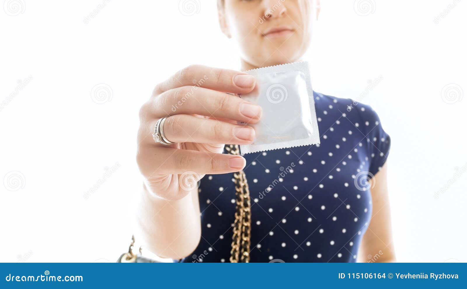 Closeup Isolated Photo Of Young Woman Showing Condom In Camera Stock