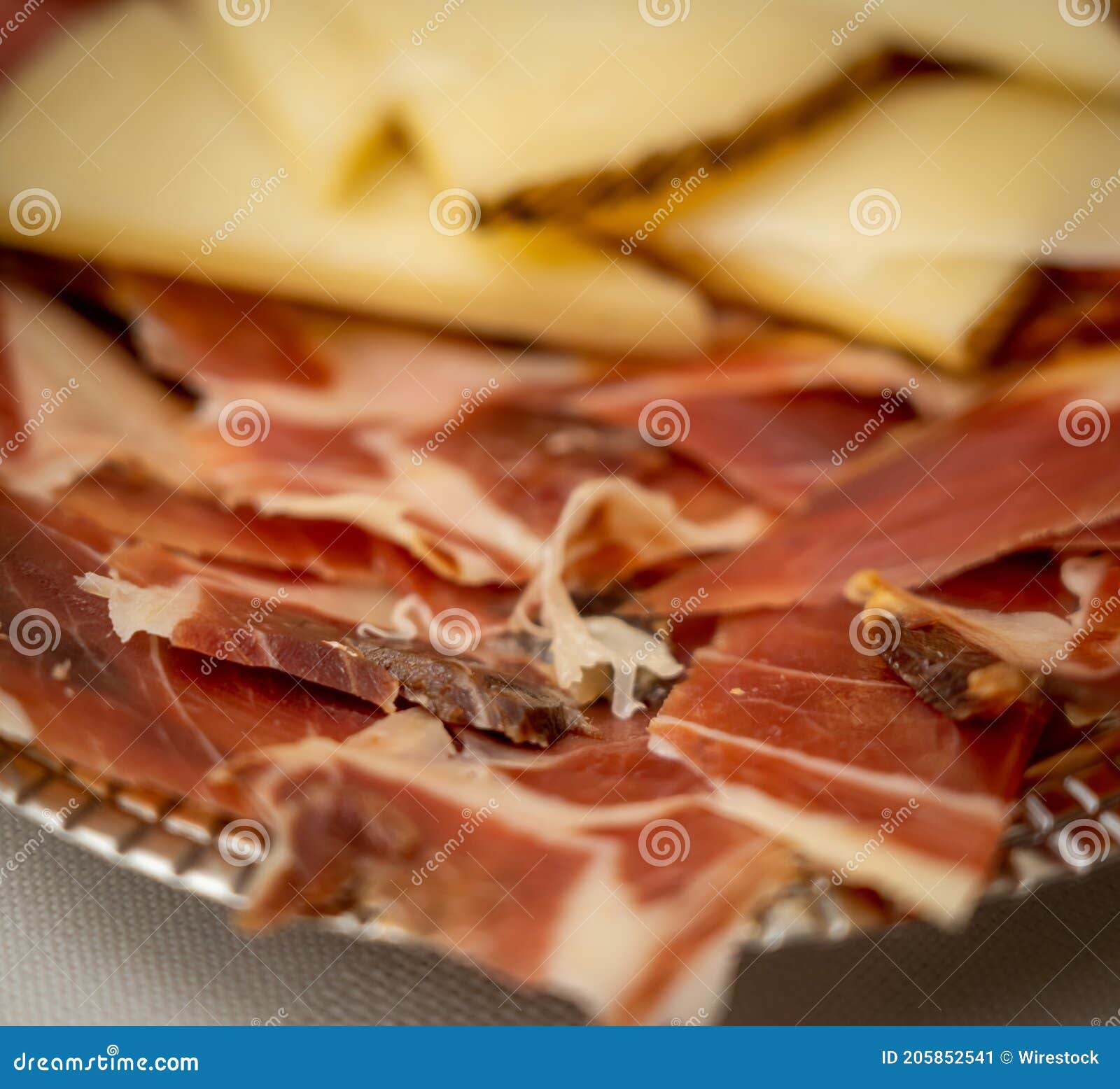 Closeup of Jamon Serrano Slices and Cheese Pon a Plate on the Table ...