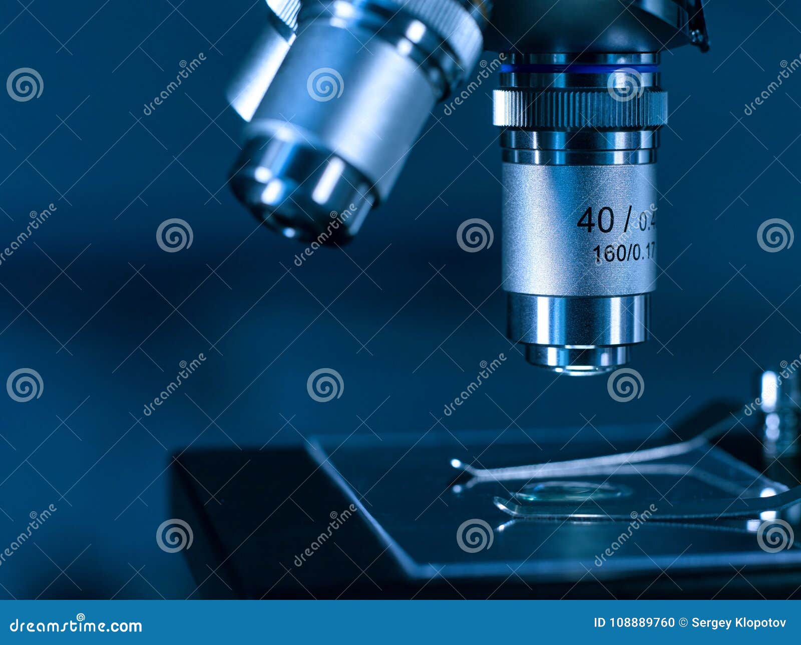 Closeup Lens of a Modern Microscope in a Research Lab on a Dark Stock ...