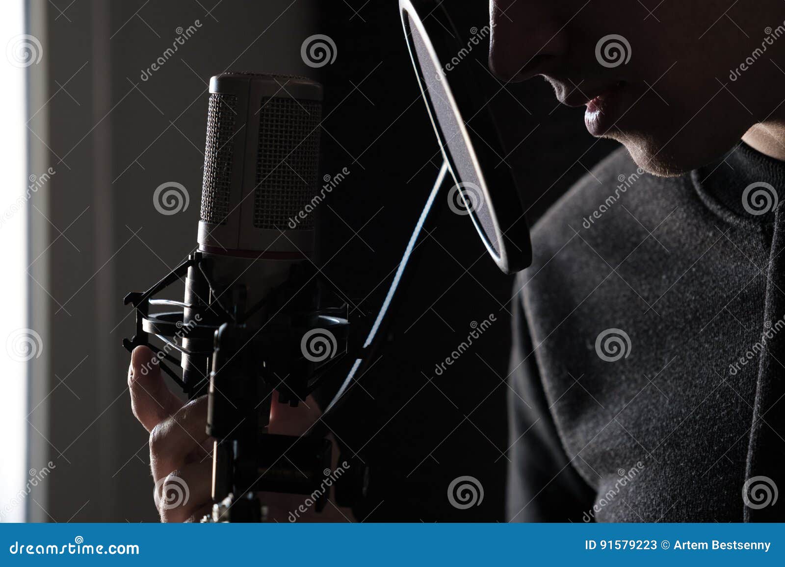 Closeup of Lips and Hands on a Microphone of a Young Man Standing in ...