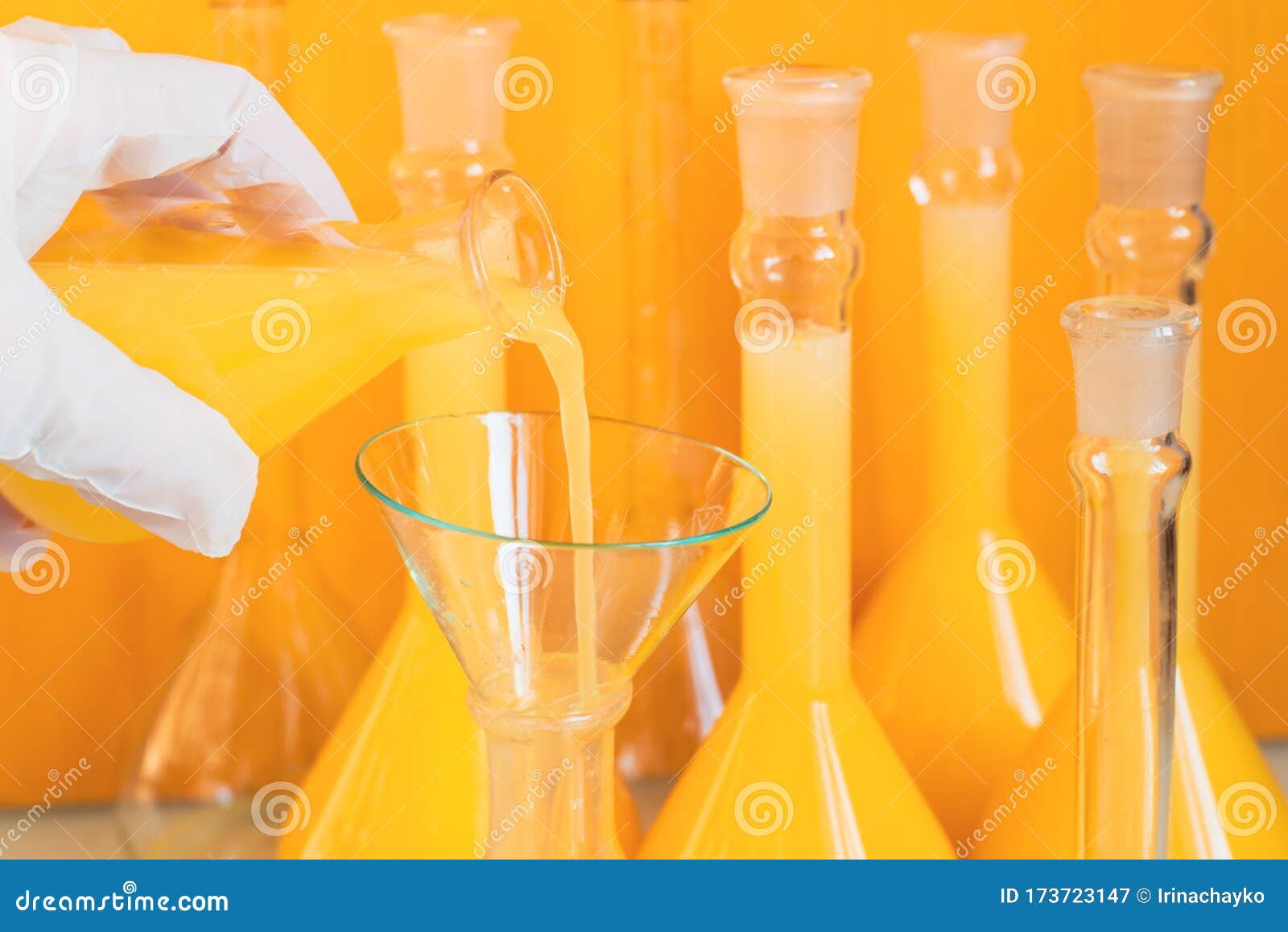 Closeup a Long Row of Glass Flasks with a Yellow Solution on a ...