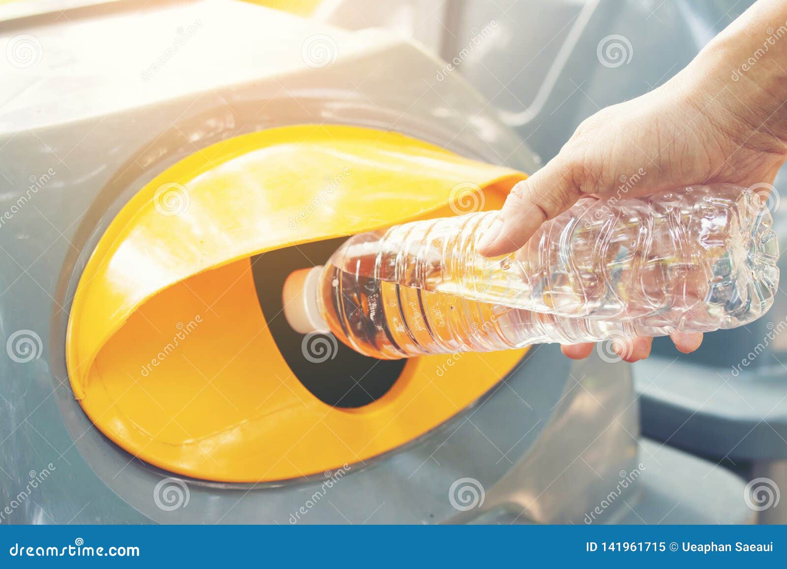 Closeup Man Hand Throwing Empty Plastic Water Bottle into the Trash ...