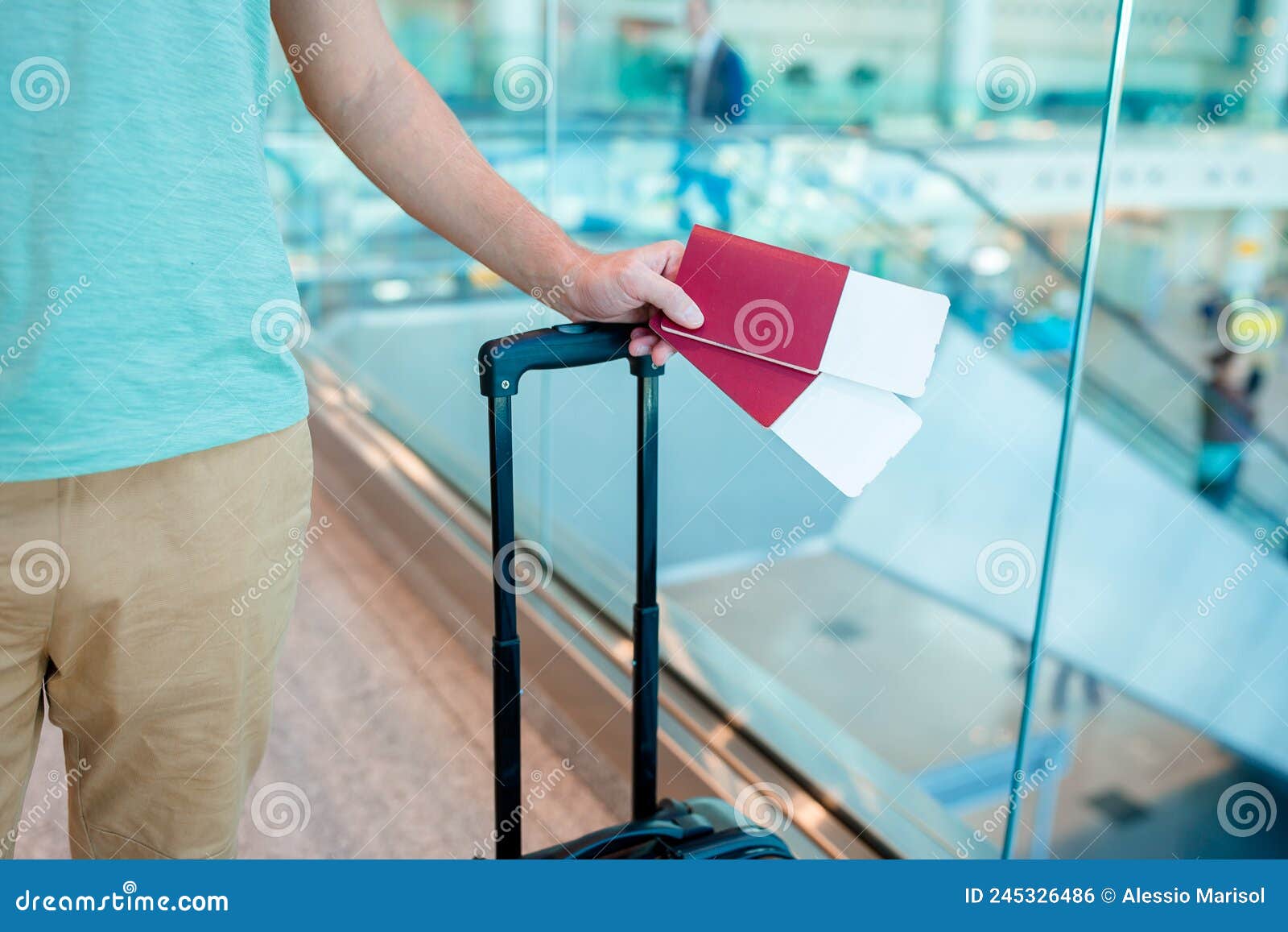 Closeup Of Man Holding Passports And Boarding Pass At Airport Stock