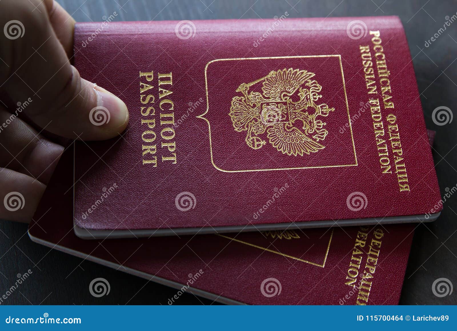 Closeup Of Man Holding Two Red Passports On Passport Control Travel