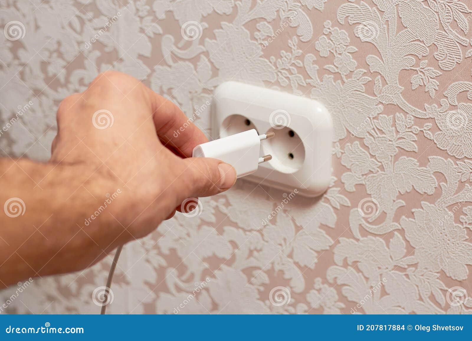 Closeup of a Man S Hand Inserting an Electrical Plug into a Wall Socket ...