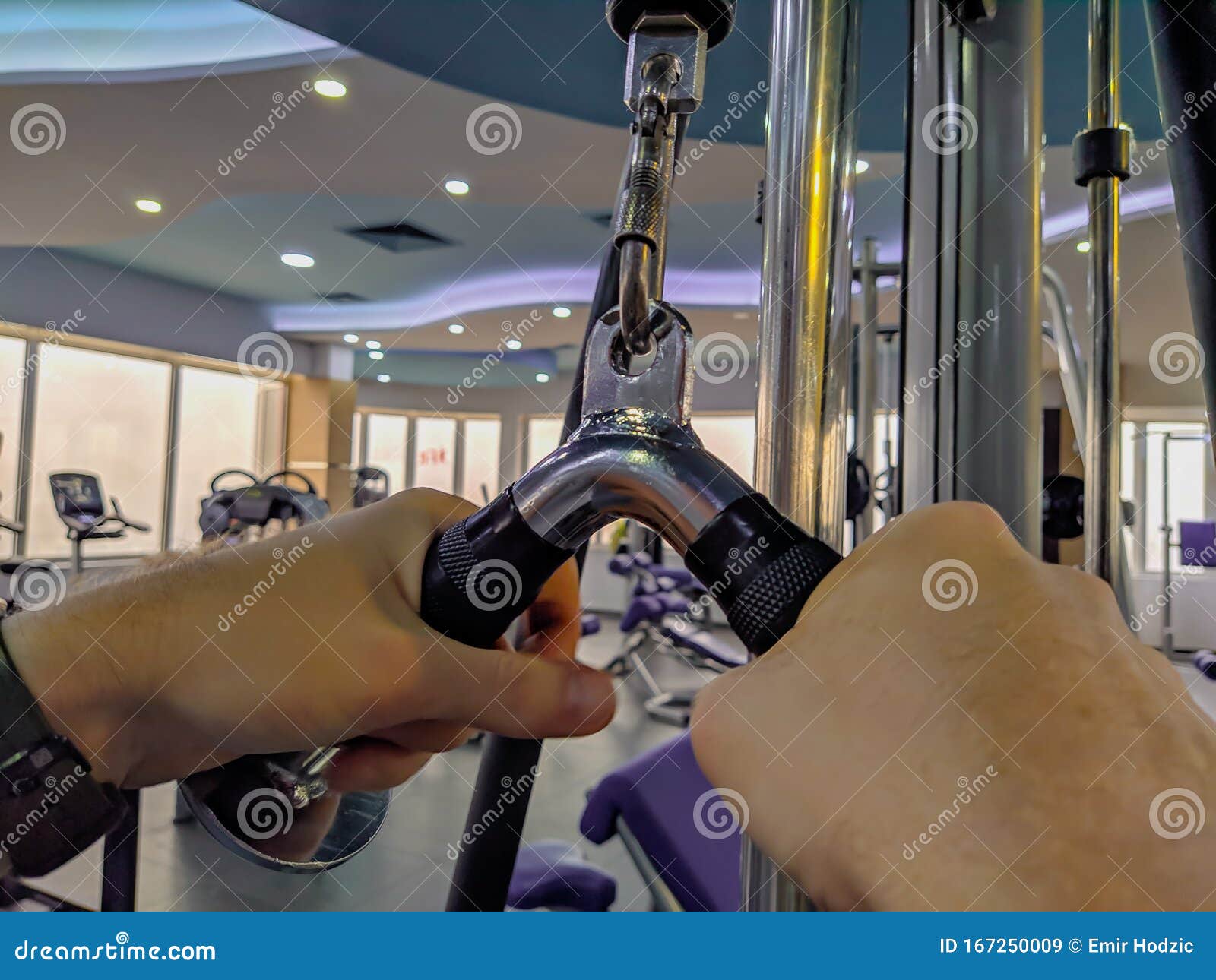 Closeup of Man`s Hands Pulling Weight in a Modern Gym Interior while ...