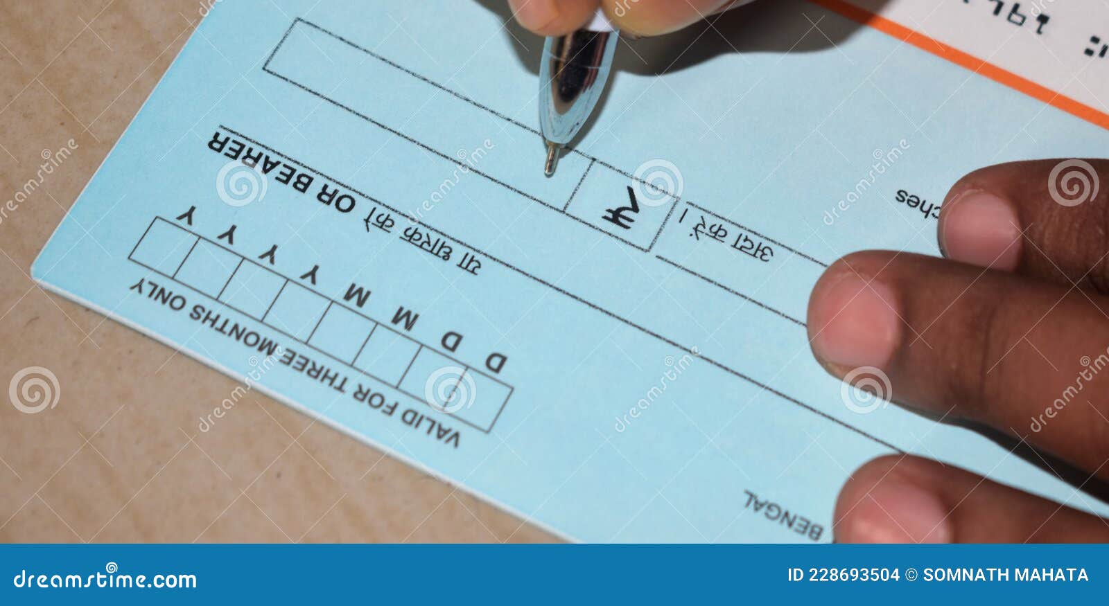 Closeup on Manâ€™s Hands Writing a Cheque. a Generic Blank Cheque Being ...