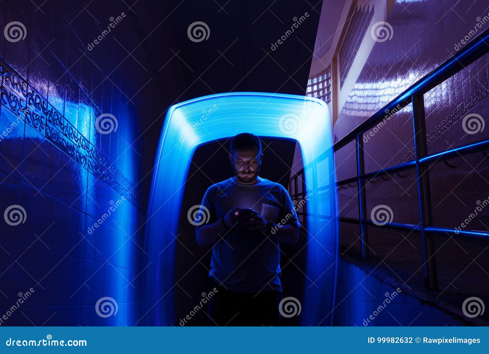Closeup of a Man Using Mobile Phone in the Dark with Blue Long E Stock ...