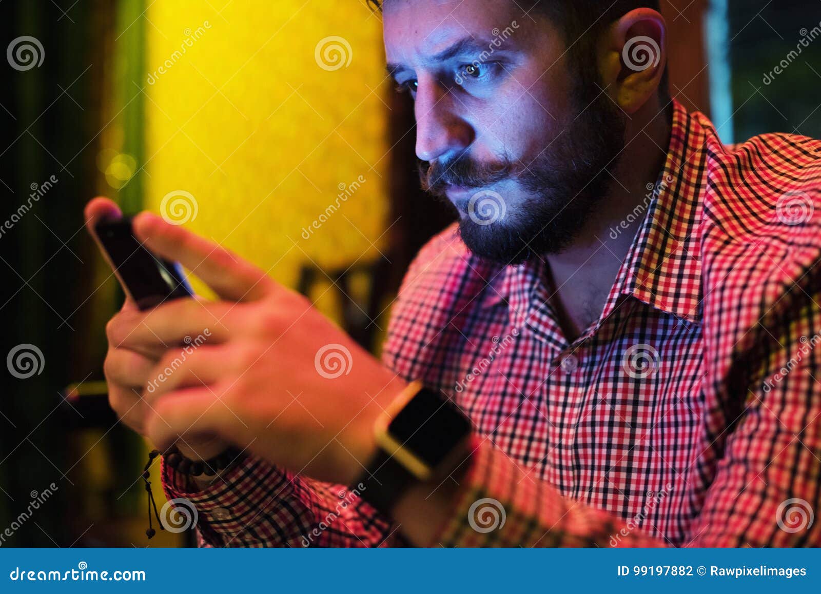 Closeup of a Man Using Mobile Phone in the Dark with Long Exposure ...