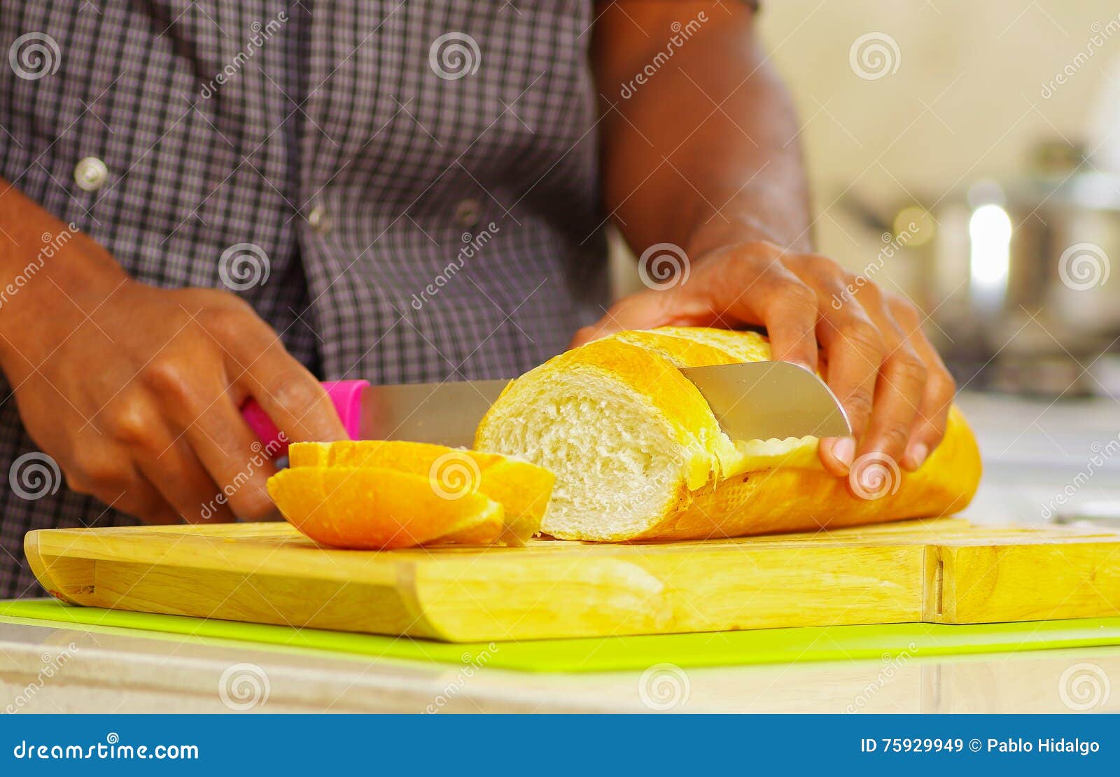 Closeup of Mans Hands Cutting Baguette on Chopping Board, Kitchen ...