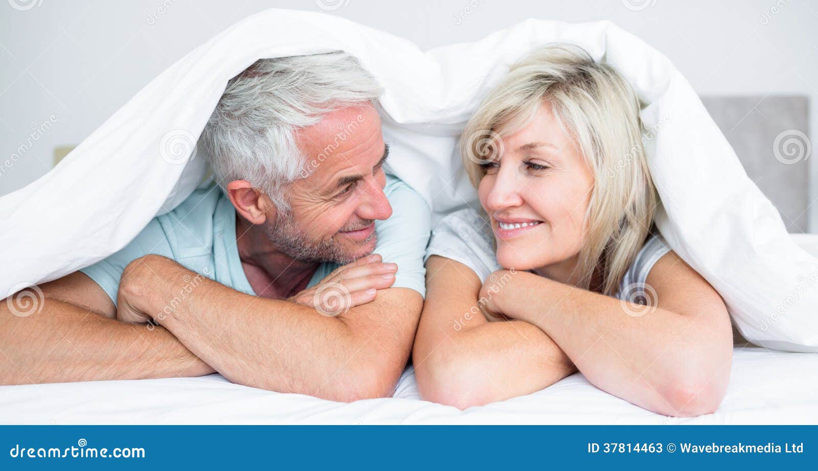 Closeup of a Mature Couple Lying in Bed Stock Image - Image of bedroom ...