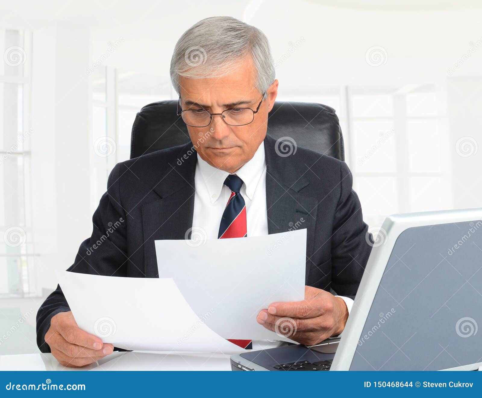 Closeup of a Middle Aged Businessman Sitting at this Desk Looking a ...