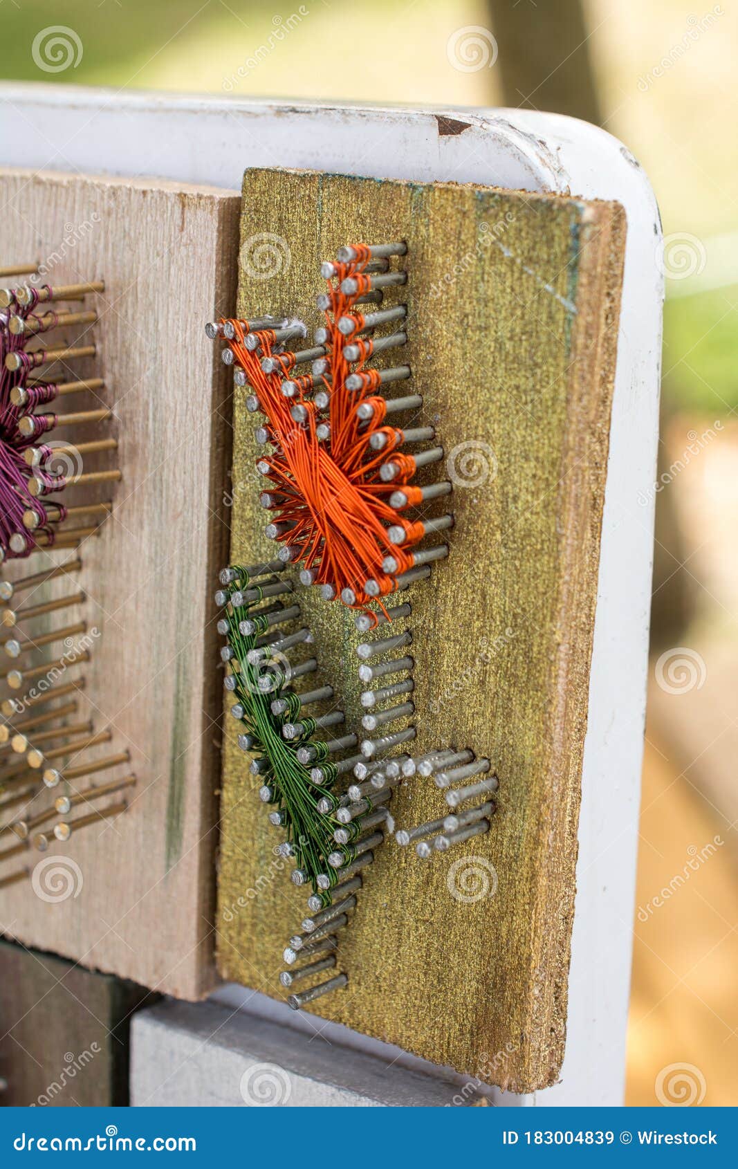Closeup of a Nails and String Art with a Tulip Design on a Wooden Board ...
