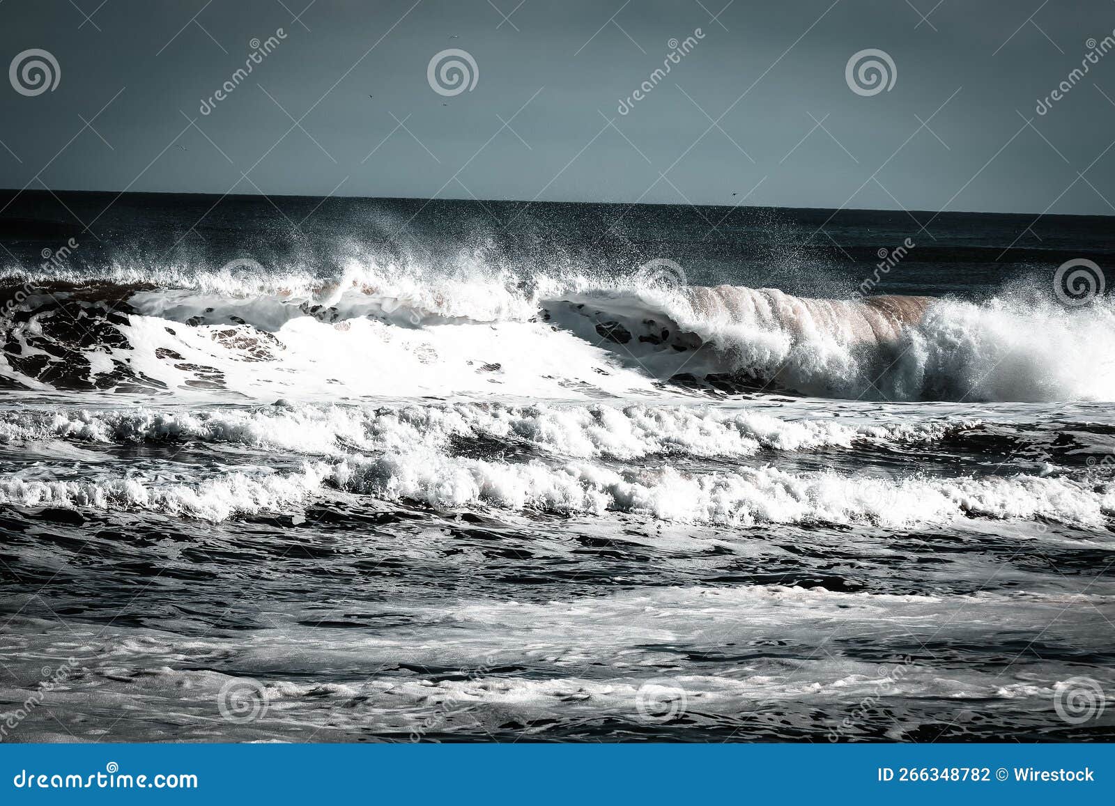 Closeup of the Ocean Foaming Waves Rolling Sandy Ashore in the Daytime ...