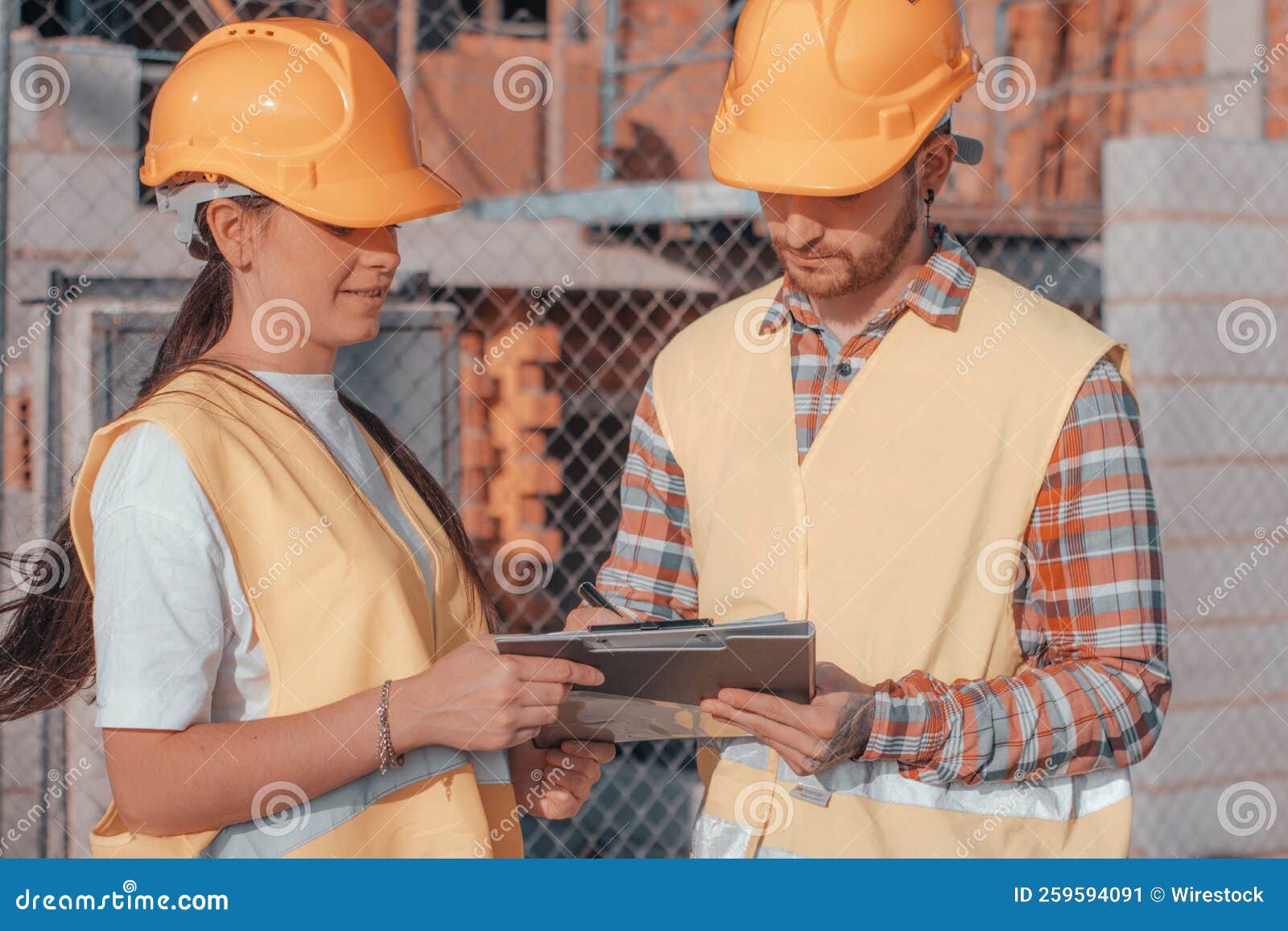 Closeup of a Pair of Builders Standing Near the Construction Site Stock ...