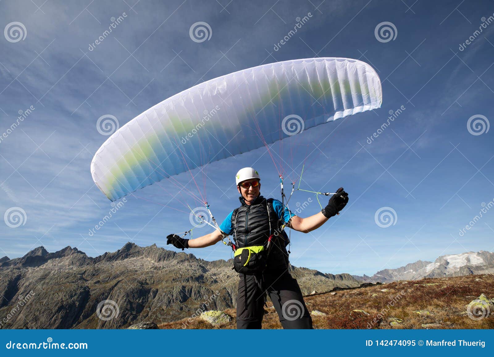 Closeup of a Paraglider Pilot Balancing His Paraglider Above His Head ...