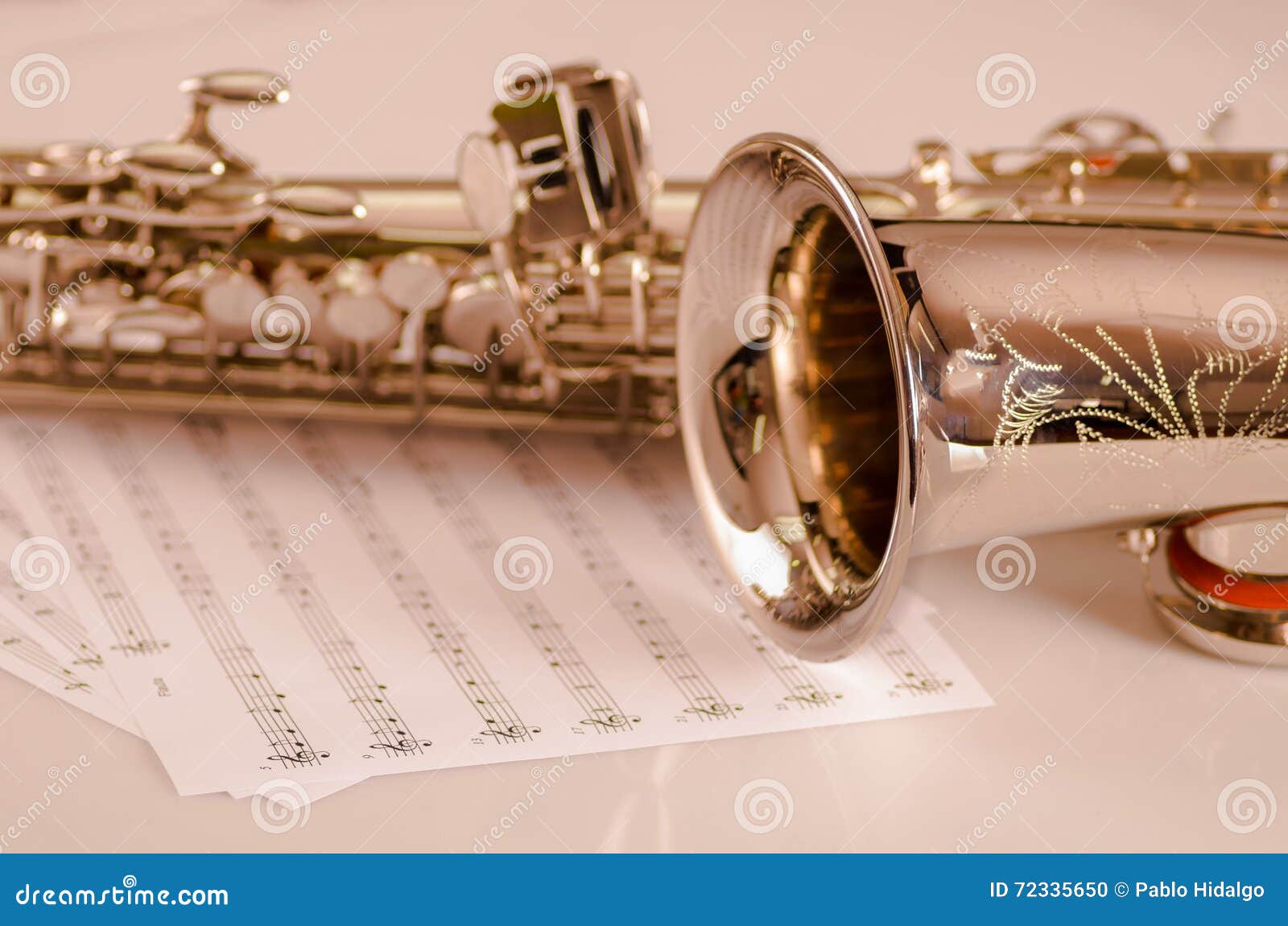 Closeup Partly View of Shiny Saxophone Lying on Musical Notes Paper ...