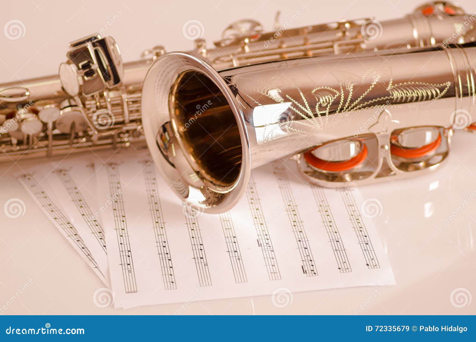Closeup Partly View of Shiny Saxophone Lying on Musical Notes Paper ...