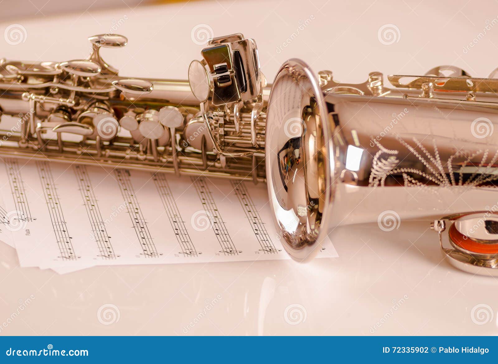 Closeup Partly View of Shiny Saxophone Lying on Musical Notes Paper ...