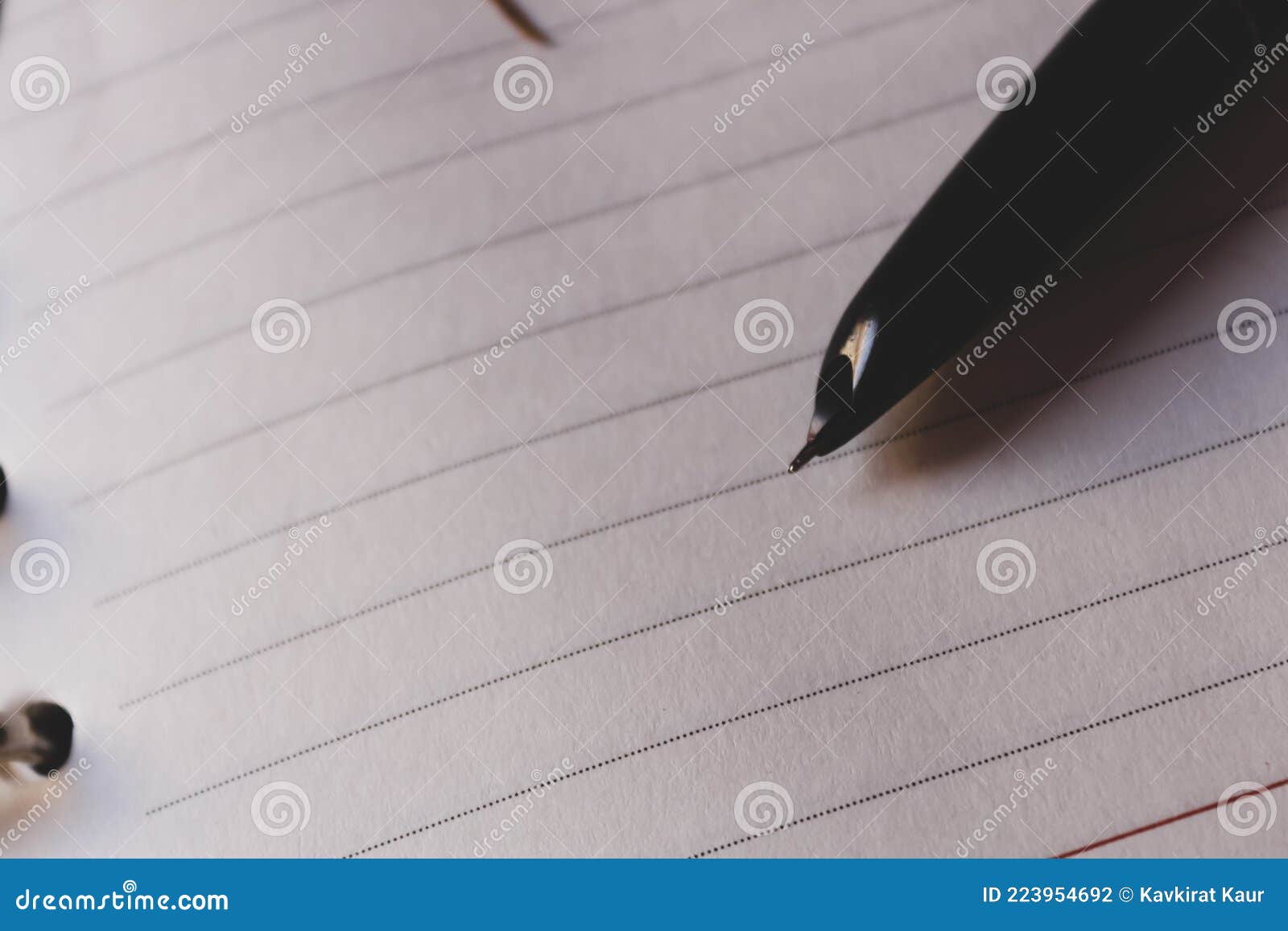 Closeup of a Pen Tip and an Empty Notebook on the Table Stock Photo ...
