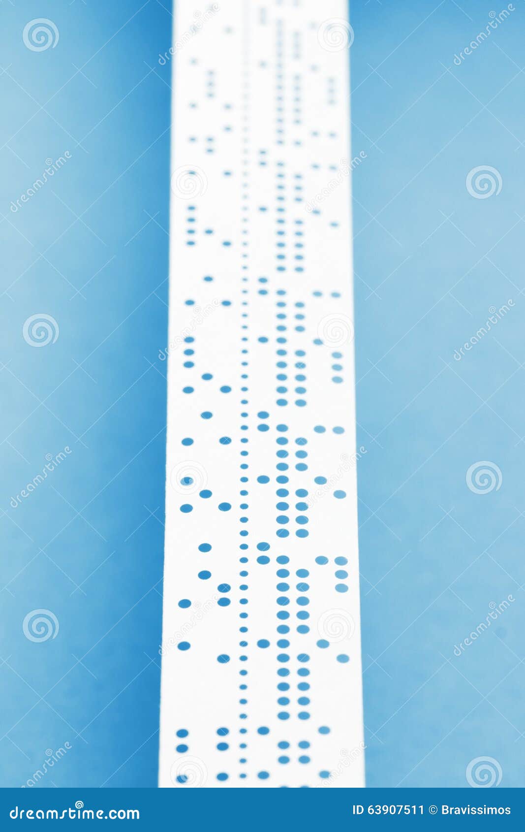 Closeup of Perforated Punched Tape on Blue Background Stock Image ...