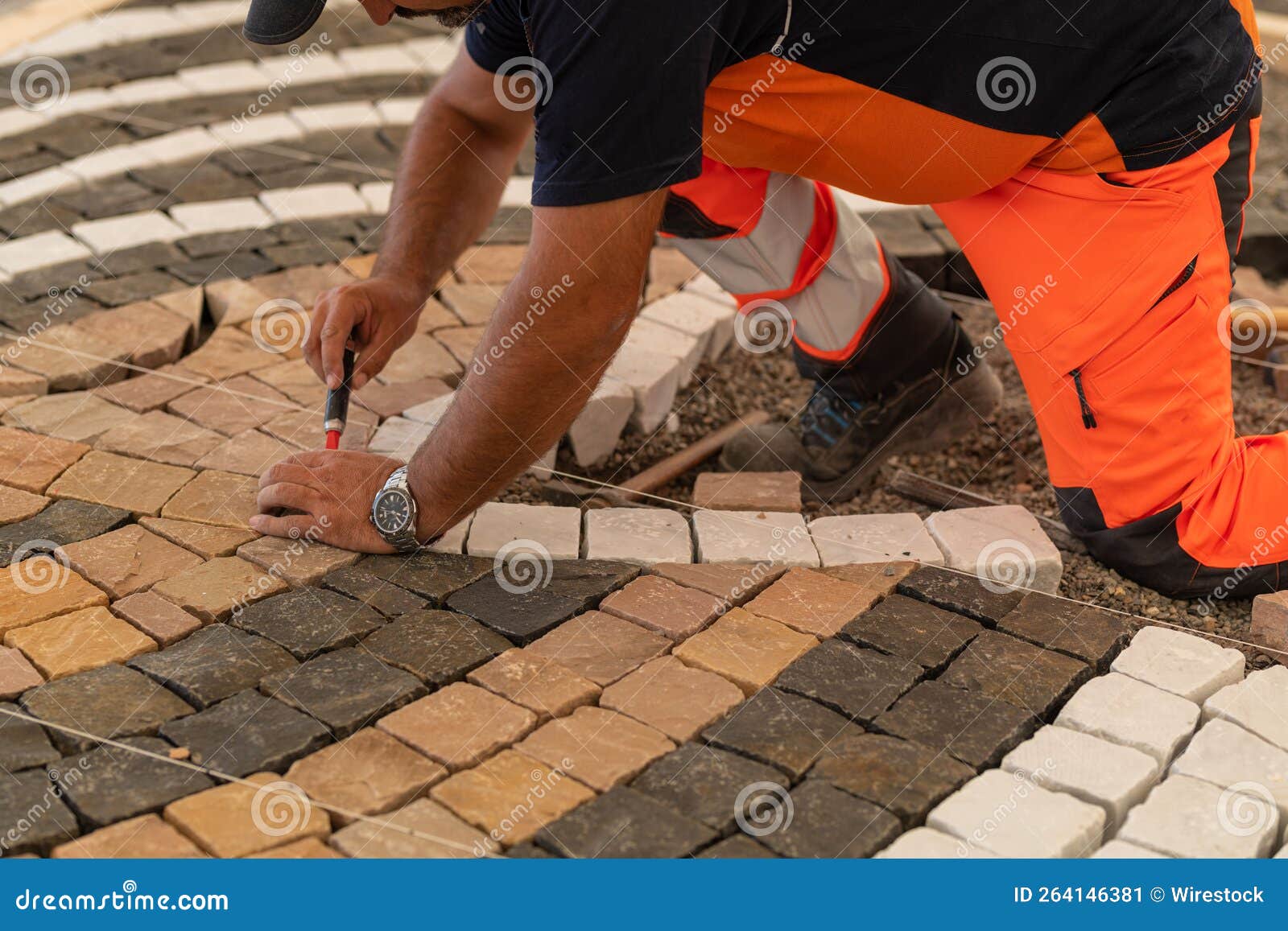 Closeup of a Person Laying Bricks and Taking Measurements in a ...