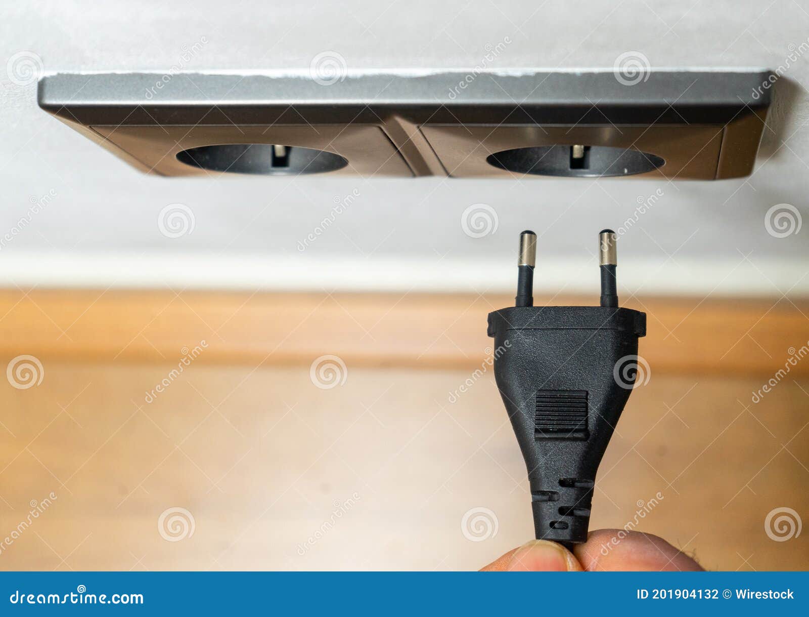 Closeup of a Person Plugging a Cable into a Socket on the Wall Stock ...