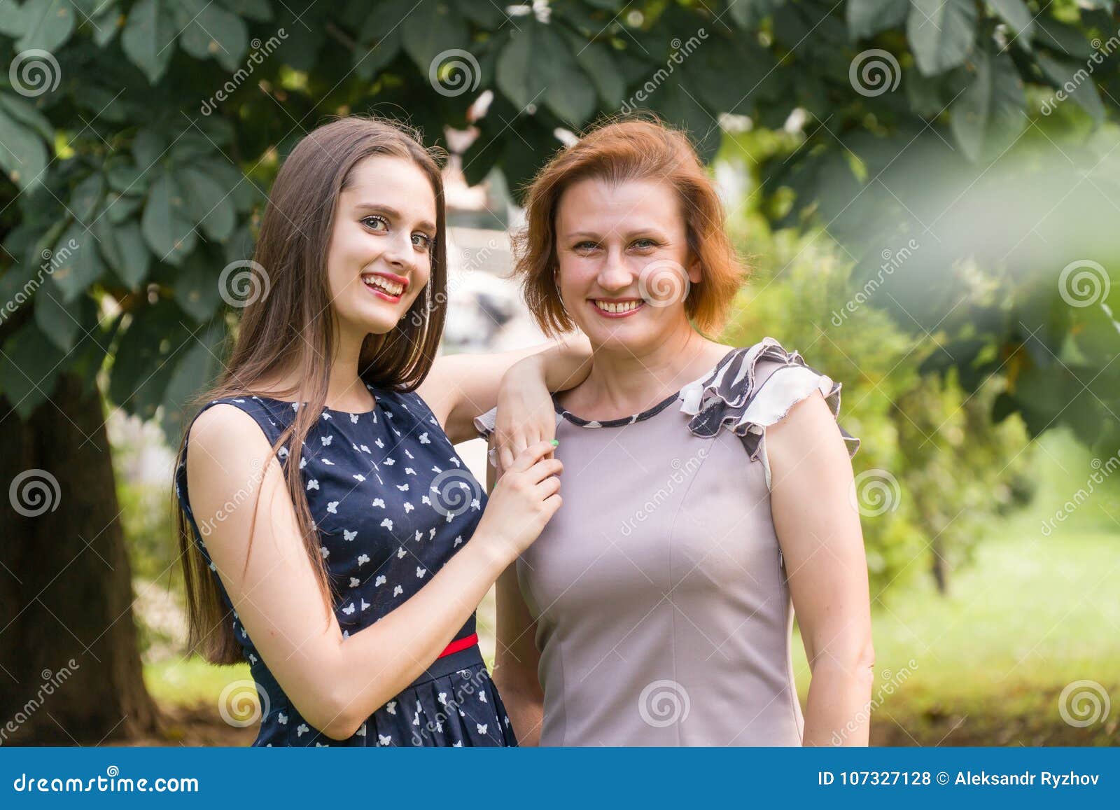 Closeup Portrait Of Adult Daughter And Mother Outdoors Pretty Brunette