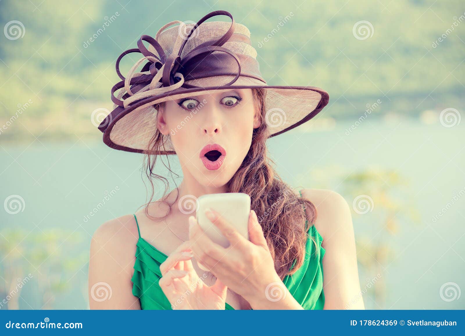 Closeup Portrait Surprised Young Woman in Hat Looking at Phone Seeing ... Closeup Portrait Surprised Young Woman in Hat Looking at Phone Seeing ...