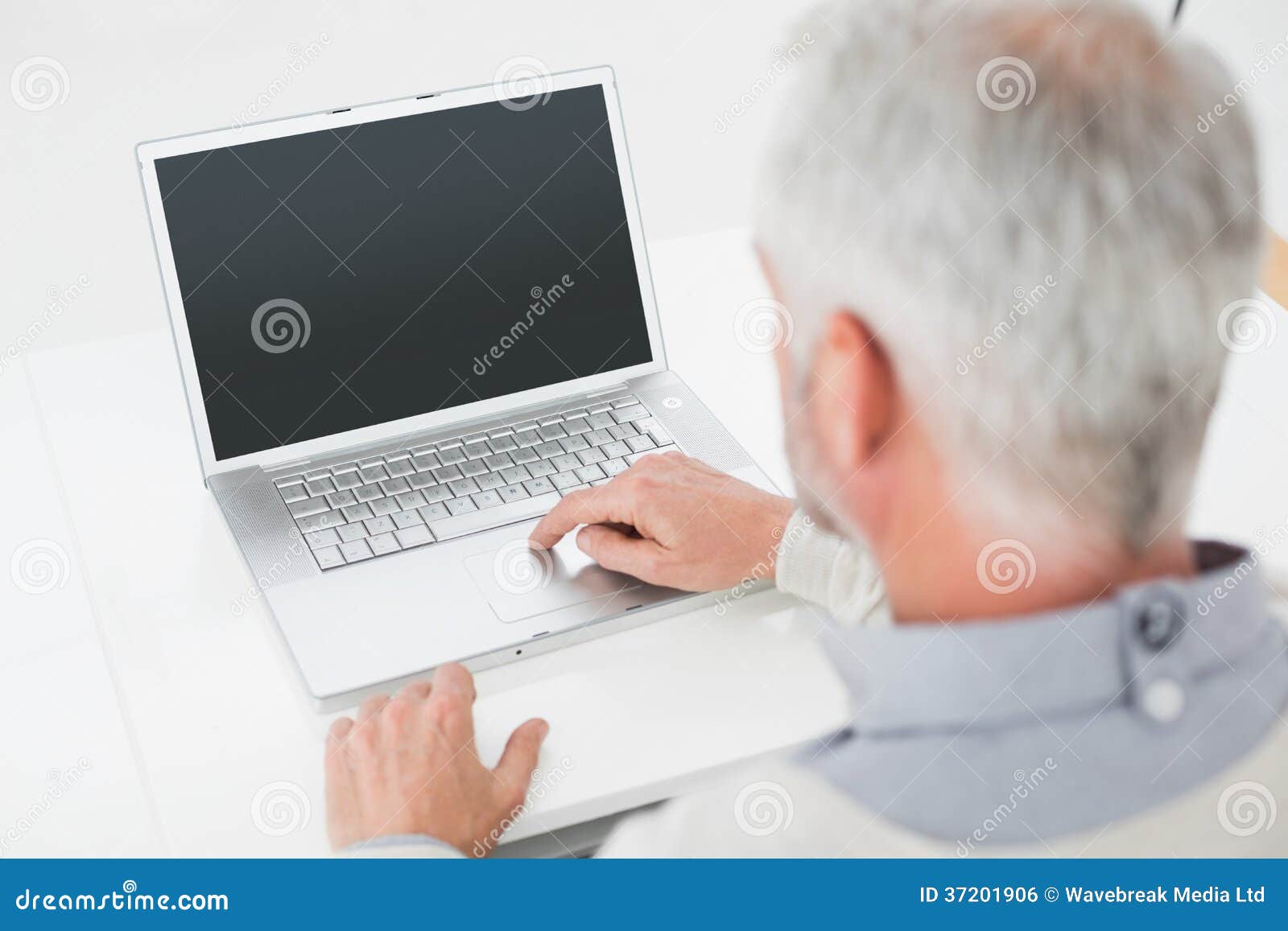 Closeup Rear View of a Grey Haired Man Using Laptop at Desk Stock Photo ...