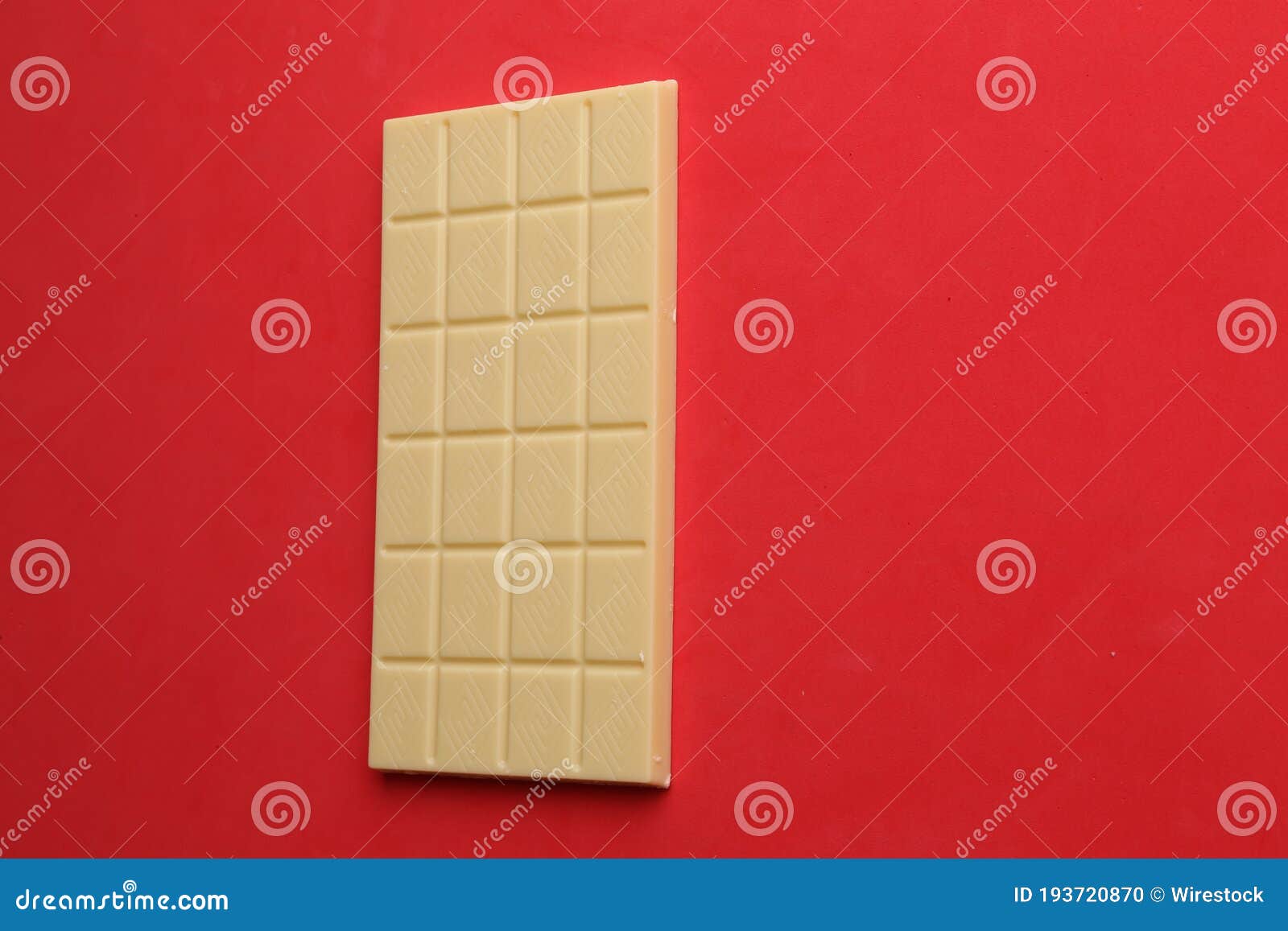 Closeup of a Rectangle White Chocolate Block on a Red Surface Stock ...