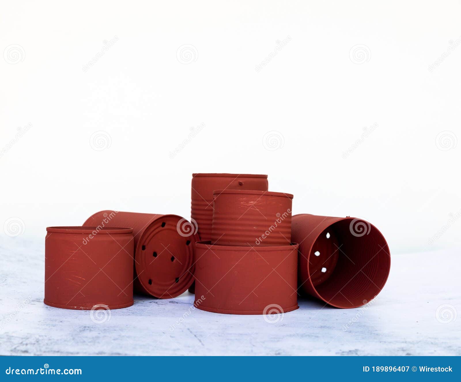 Closeup of Red Cans in Different Sizes with Holes Isolated on a White ...