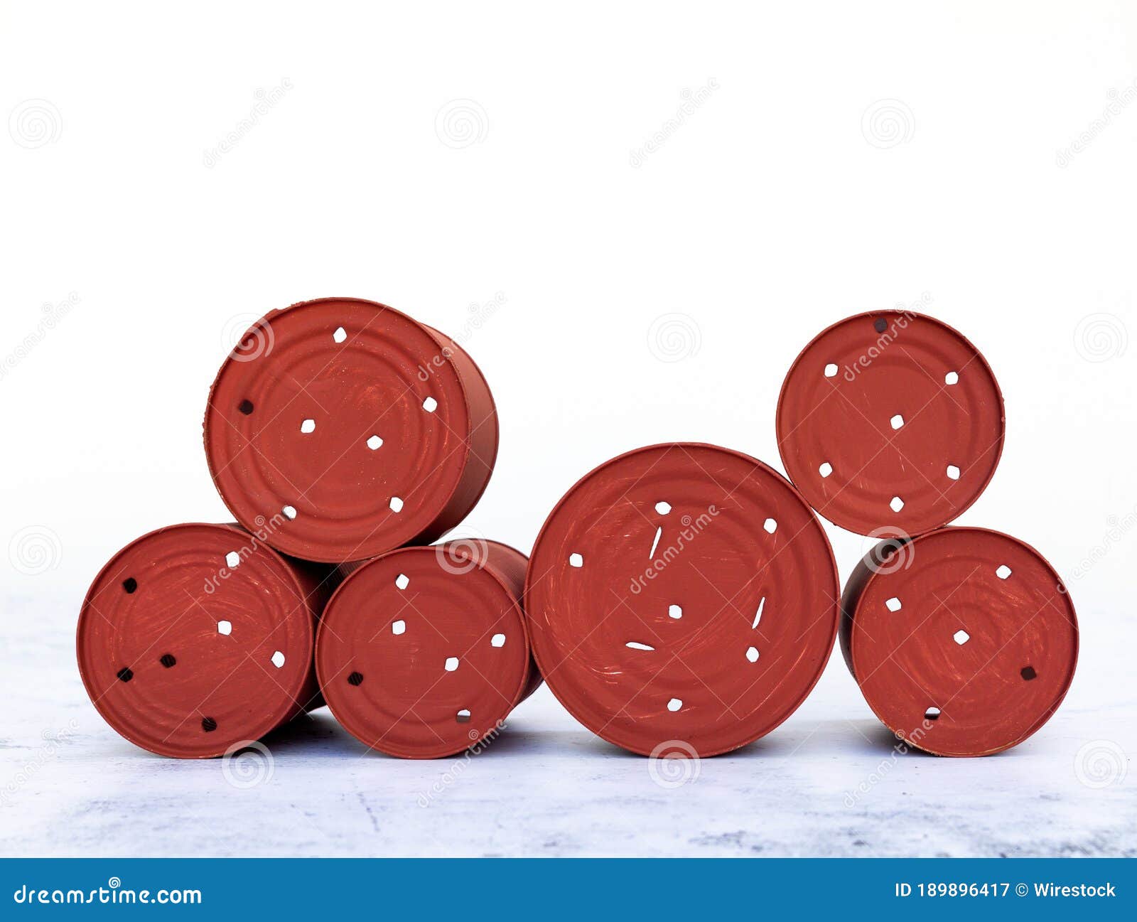 Closeup of Red Cans in Different Sizes with Holes Isolated on a White ...
