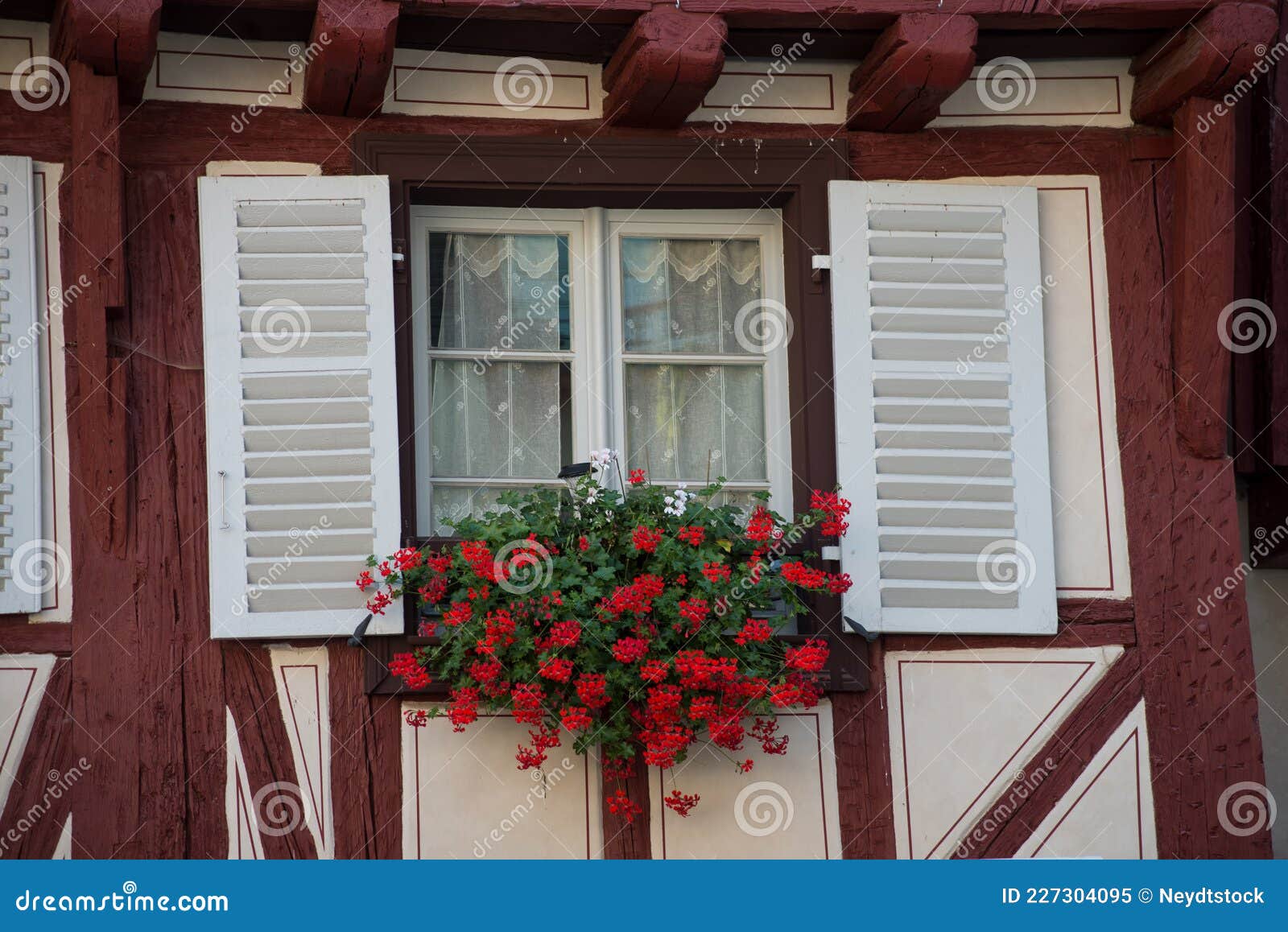 Red Geraniums on Medieval Building Facade in the Street Stock Image ...