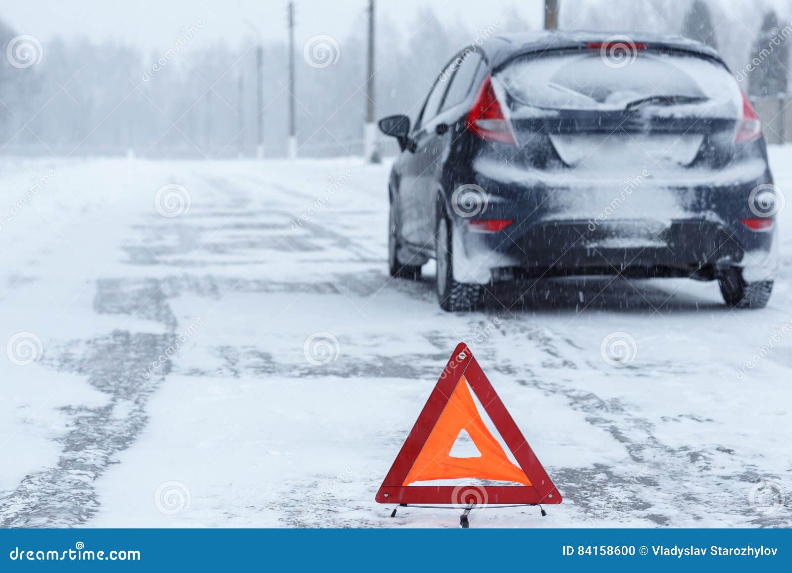 Closeup of Red Warning Triangle with a Broken Down Car in Winter Stock ...