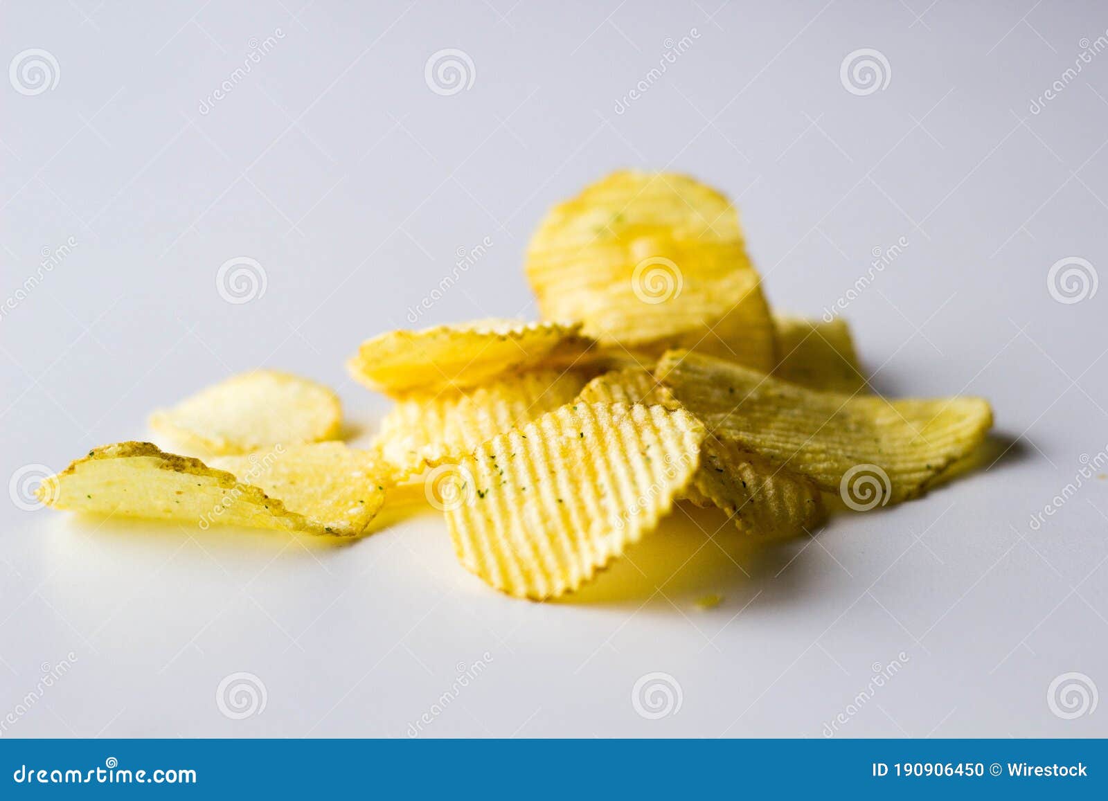 Closeup of Ridge Cut Crisp Potato Chips on a White Surface Stock Photo ...