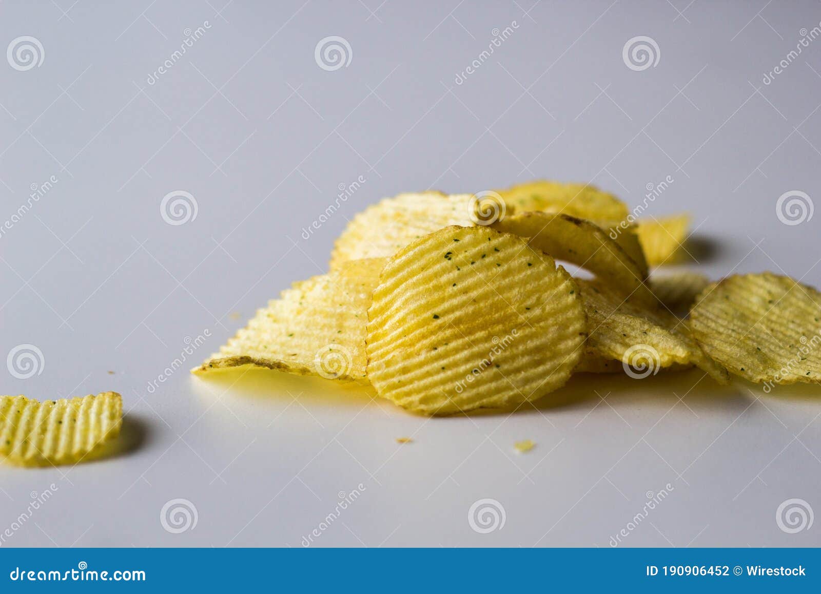 Closeup of Ridge Cut Crisp Potato Chips on a White Surface Stock Photo ...