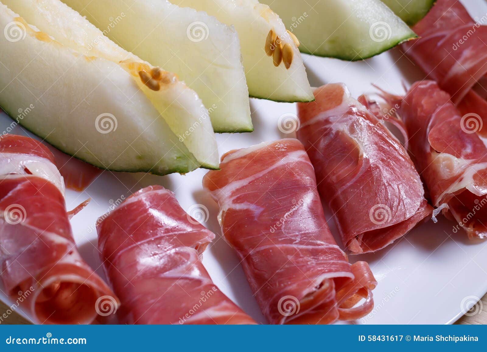 Closeup of Rolled Slices of Cured Pork Ham Jamon with Melon Stock Image ...