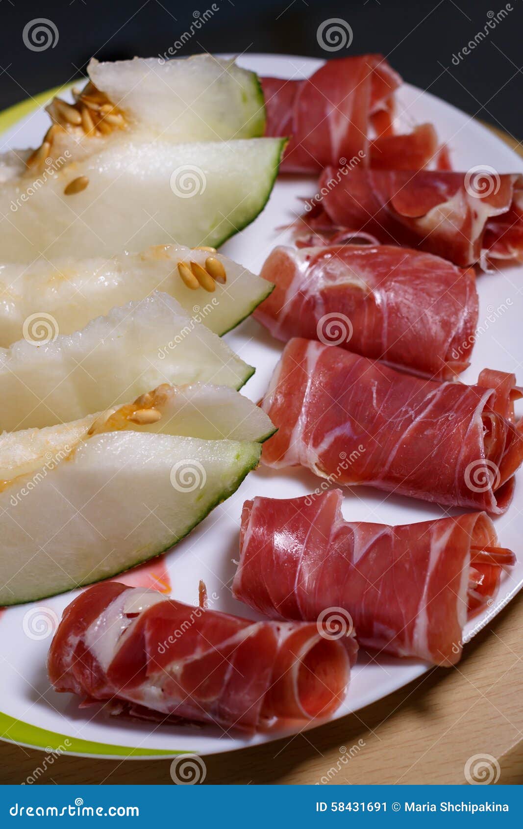 Closeup Of Jamon Serrano Slices And Cheese Pon A Plate On The Table ...