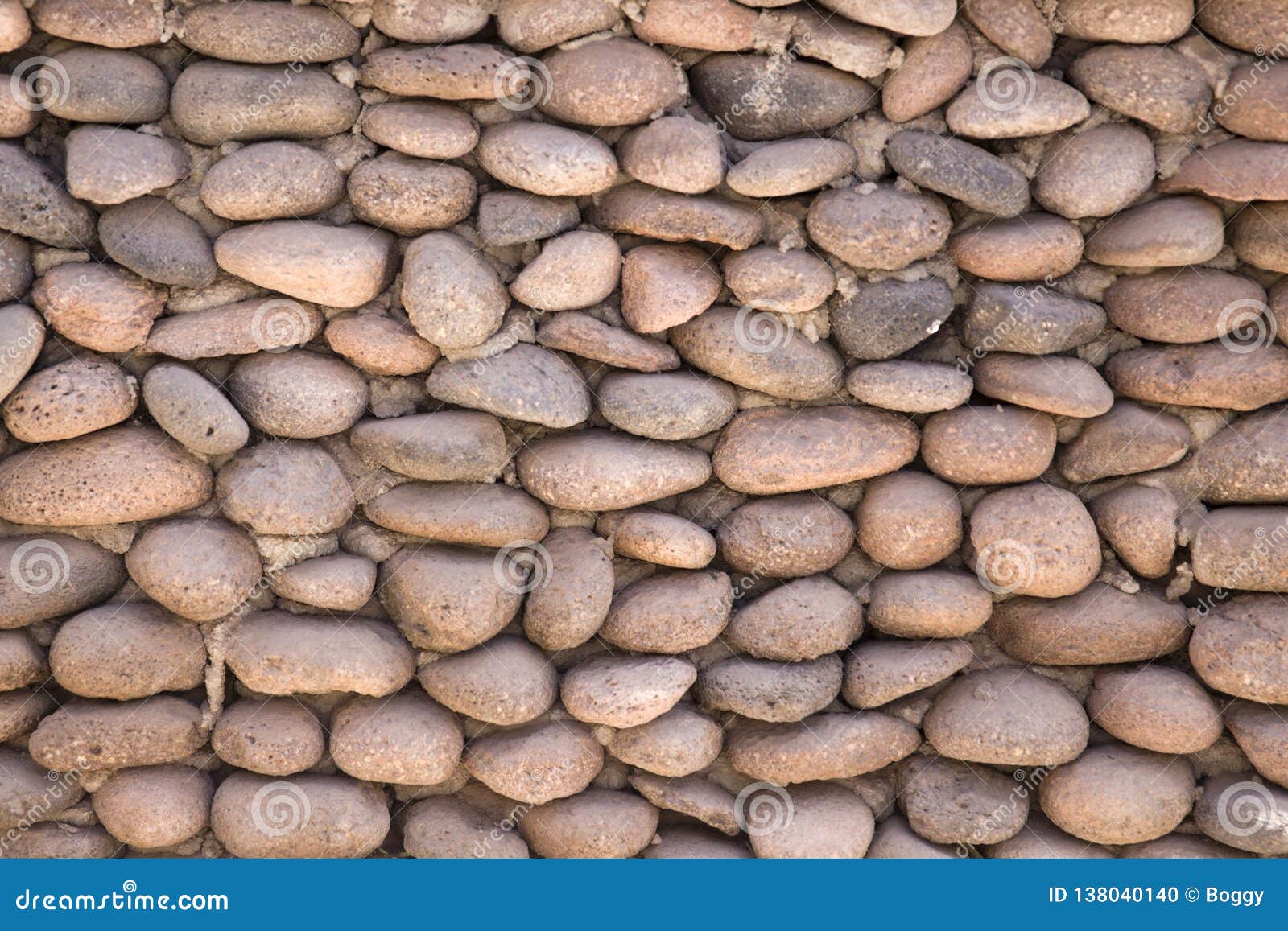 Round cobblestone wall stock photo. Image of abstract - 138040140