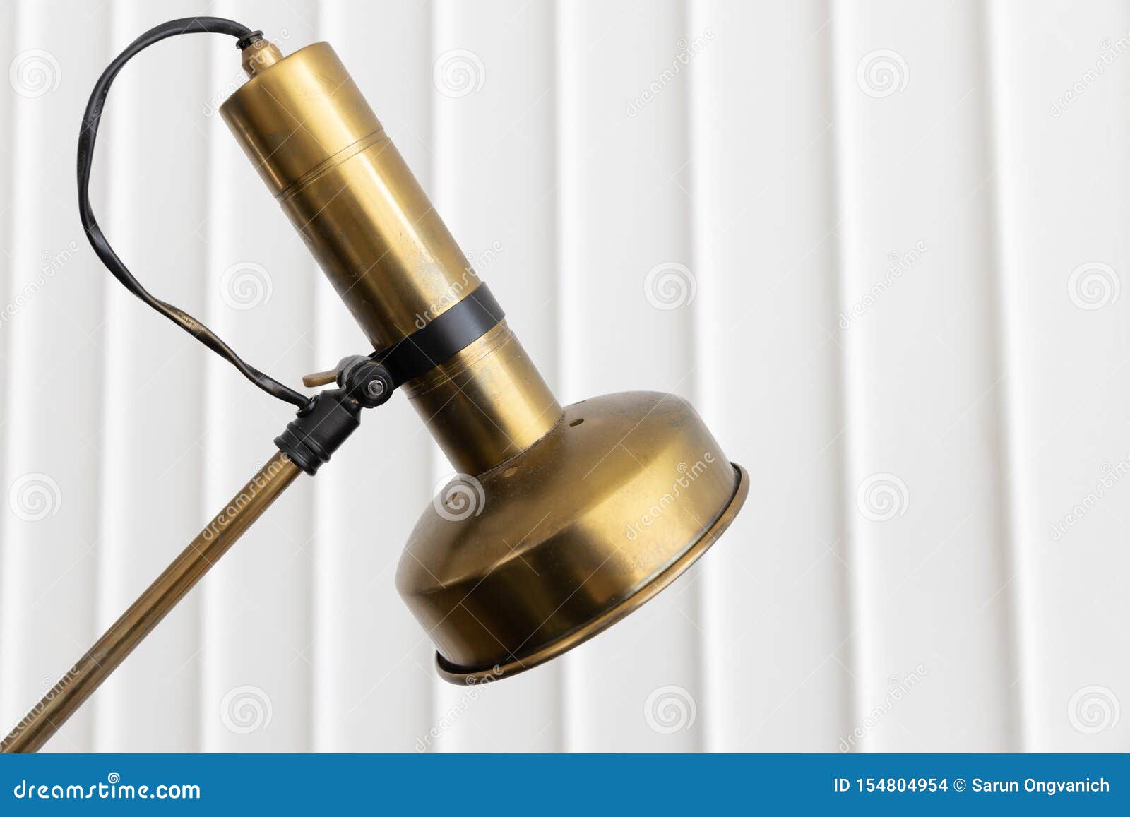 Closeup of Rustic Brass Metal Adjustable Arm Lamp on White Wall ...