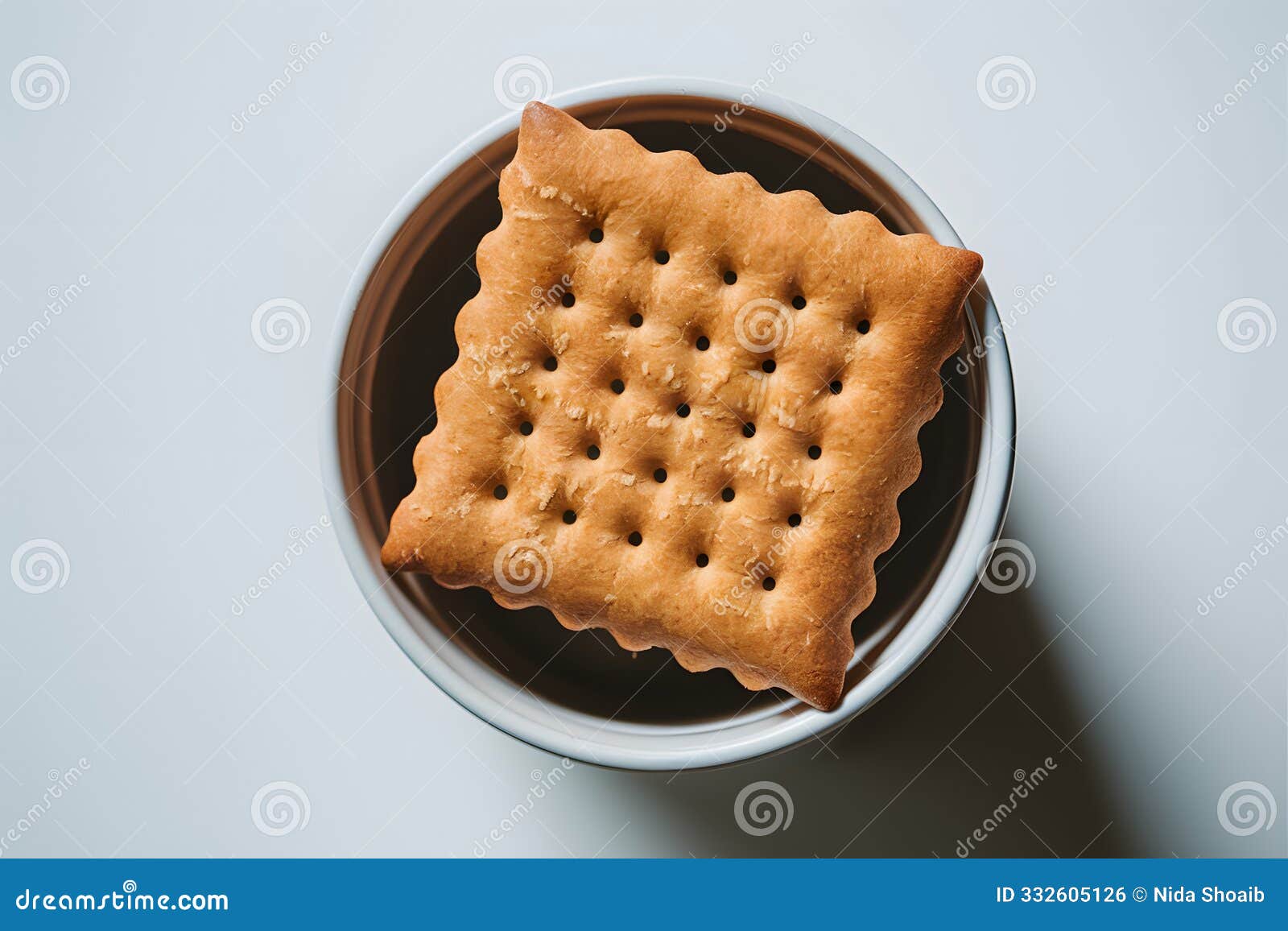 Closeup of a Scalloped Edge Rectangular Cracker in a White Container on ...