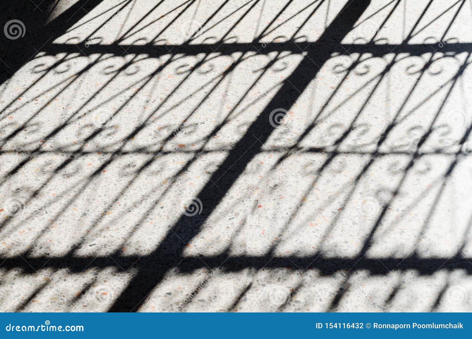 A Closeup Section Metal Fence Shadow on the Sidewalk Stock Photo ...