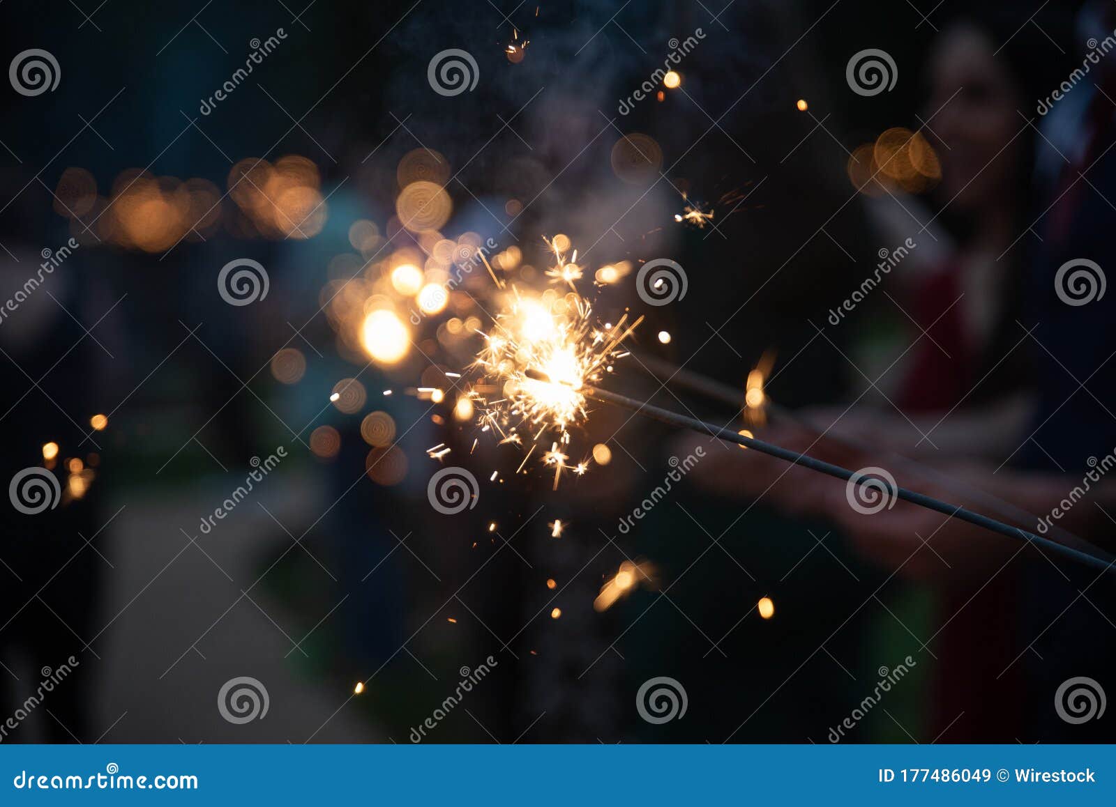 Closeup Shot of a Burning Sparkler with Bokeh Lights in the Background ...