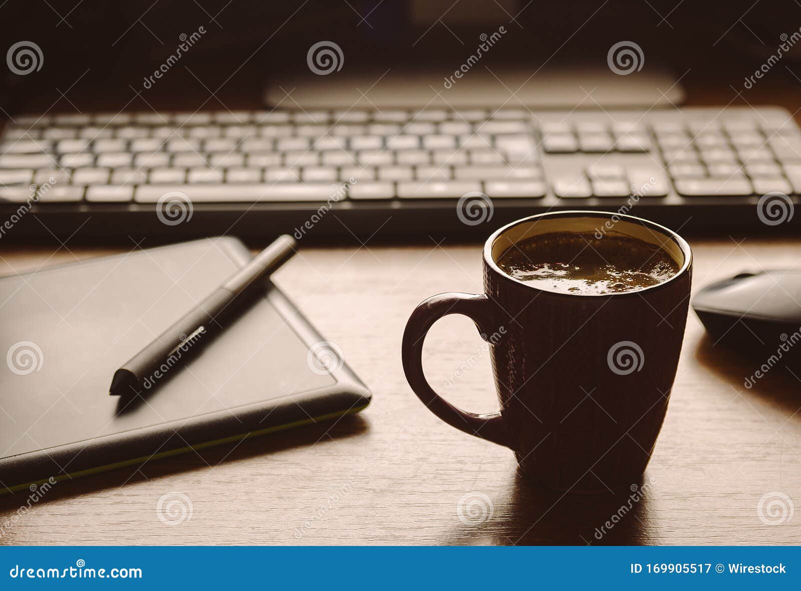 Closeup Shot of a Cup of Coffee and a Notebook in Front of the Keyboard ...