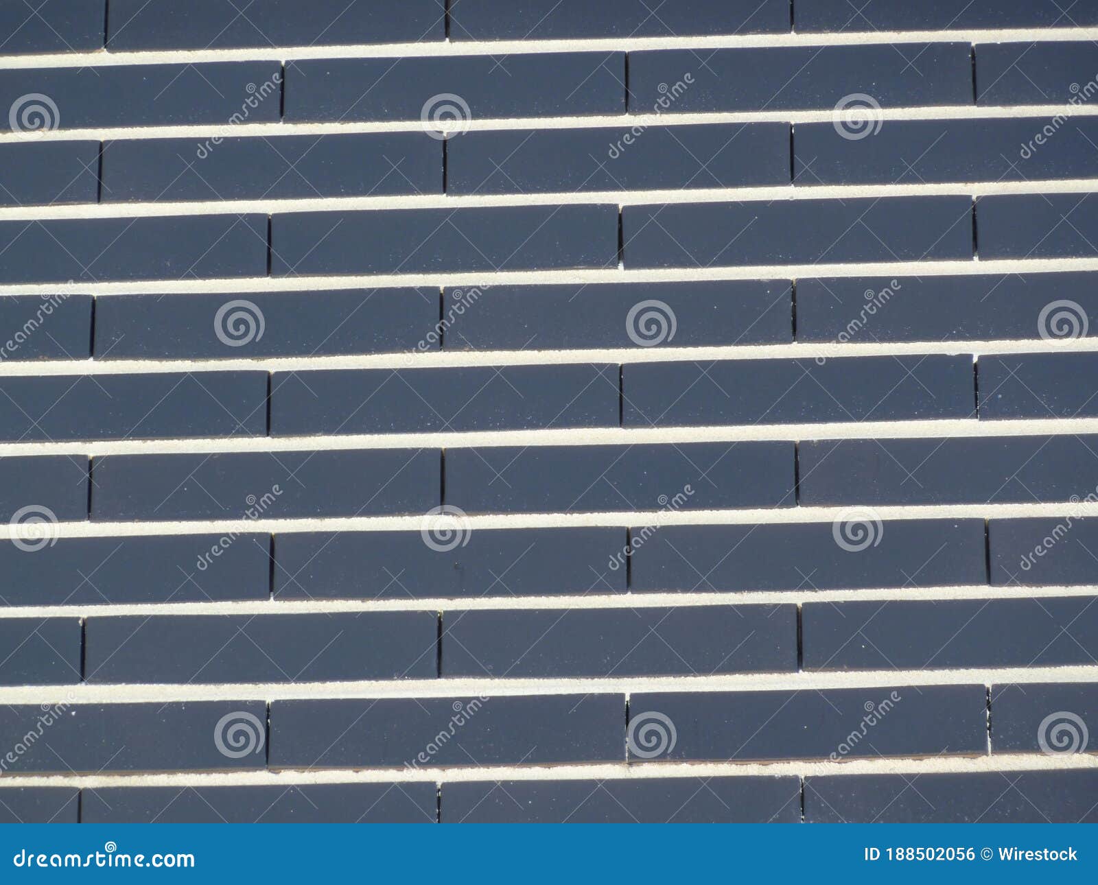 Closeup Shot of a Dark Gray Brick Wall of a Building Stock Photo ...