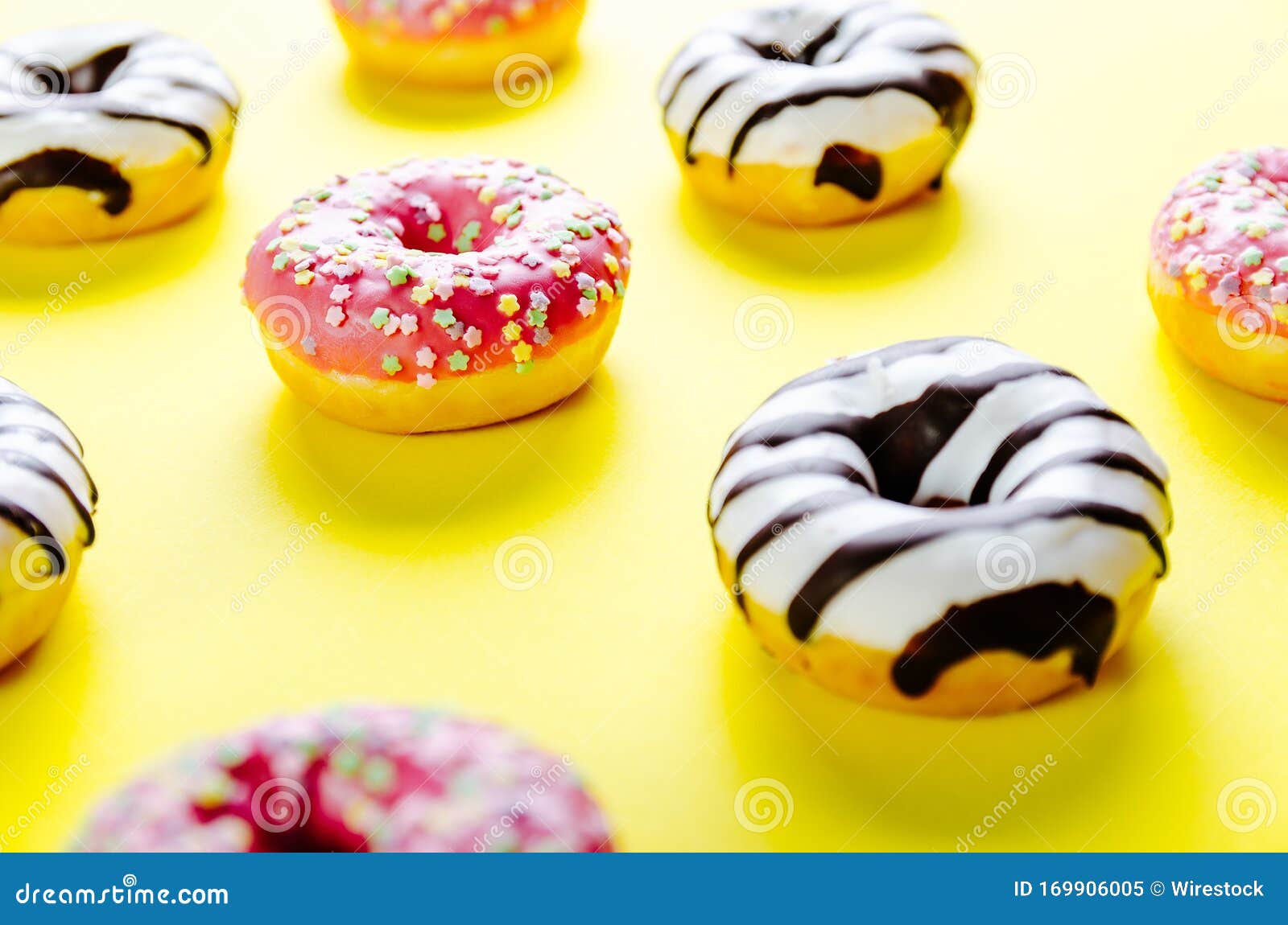 Closeup Shot of Delicious Donuts on a Yellow Surface - Perfect for a ...