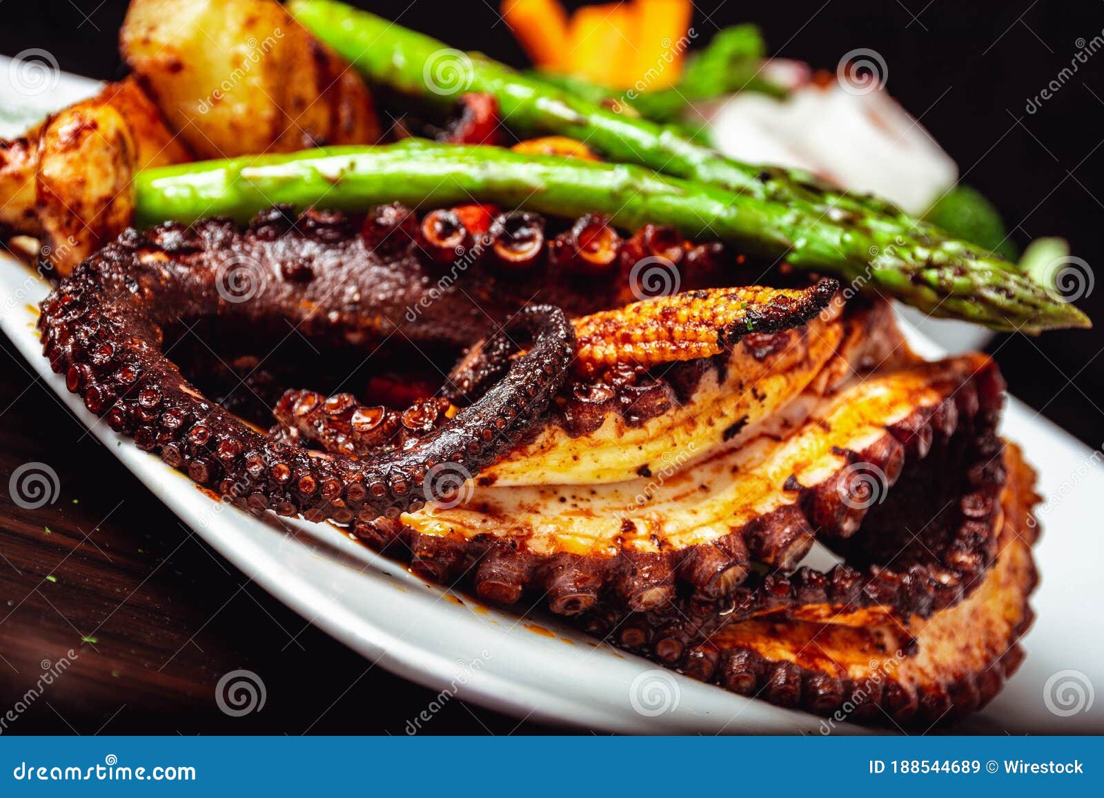 Closeup Shot of a Delicious Roasted Octopus Dish with Roasted Asparagus ...